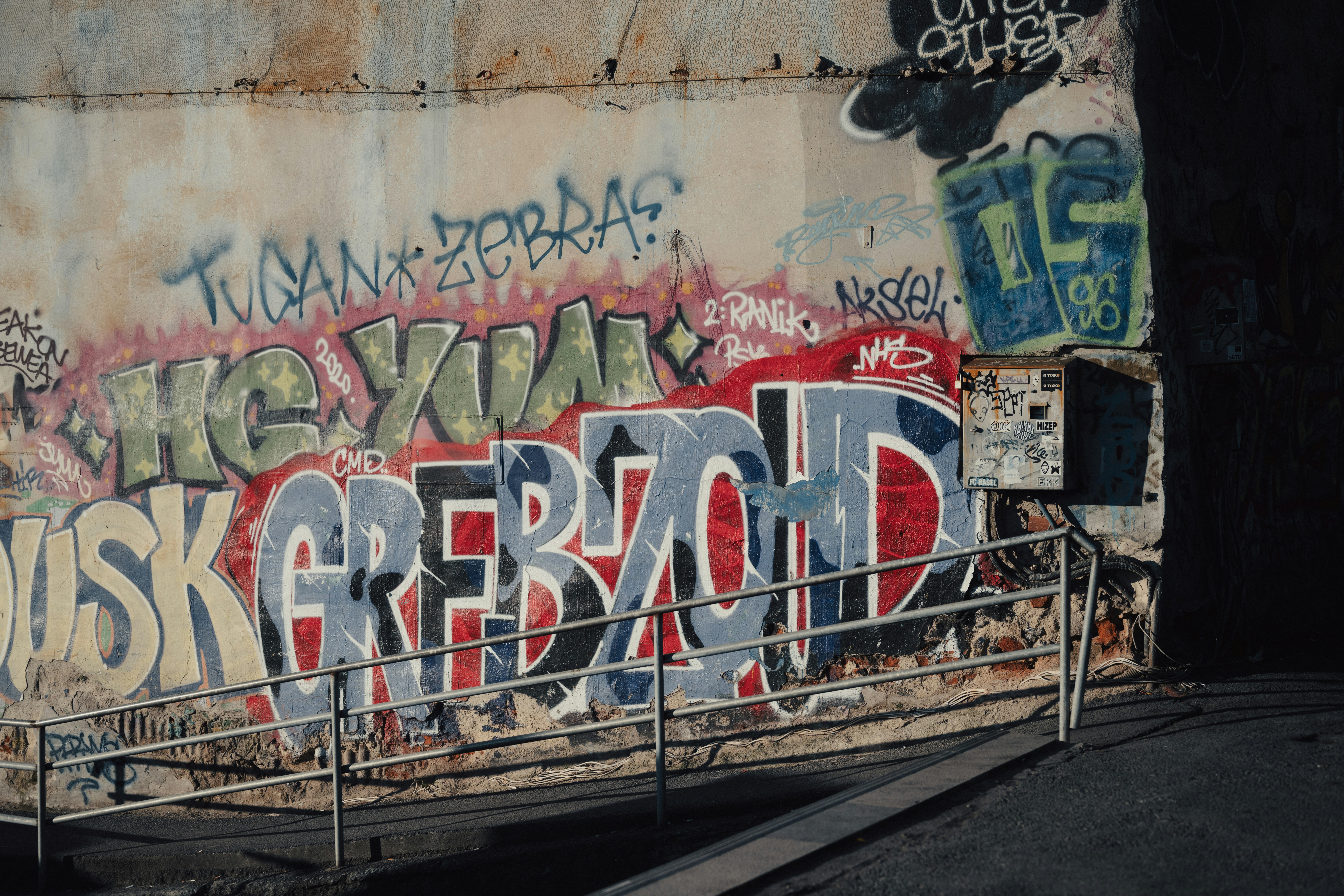 Railside Graffiti Canvas: Bold Letters on a Weathered Wall