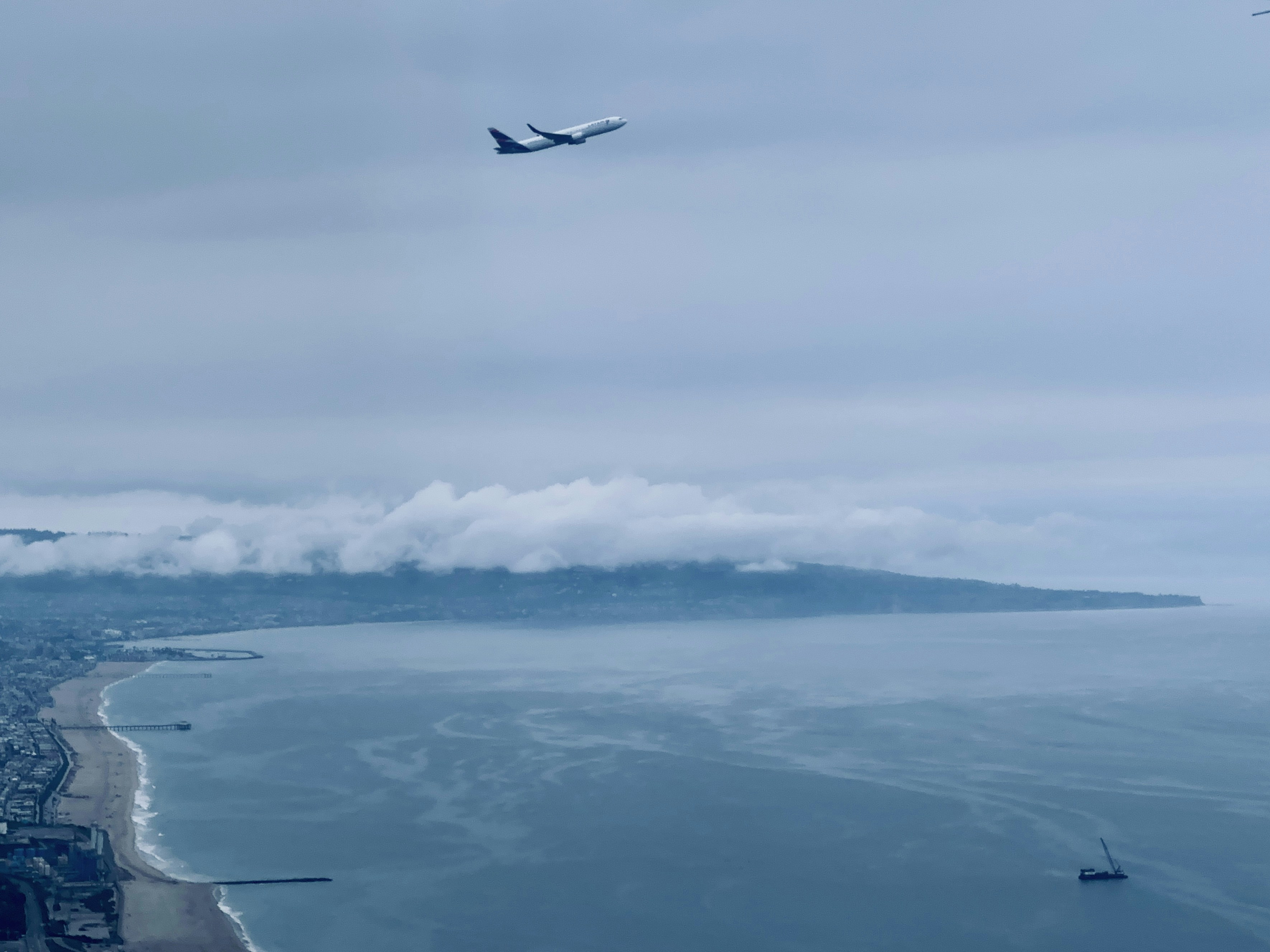 A Pacific-Edge Transit: Jet Traces the Cloud Band Above the Coast