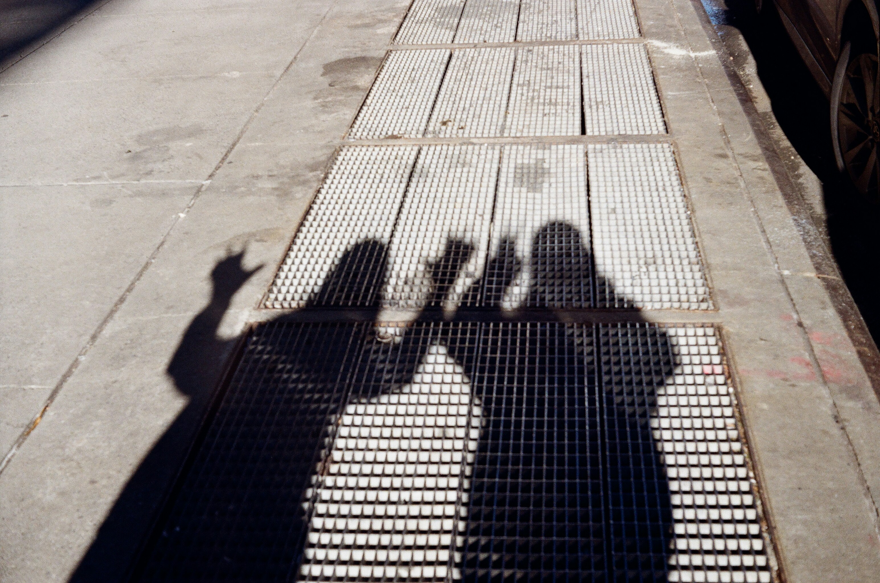 A shadow of two people standing on a sidewalk photo – Free Usa Image on ...