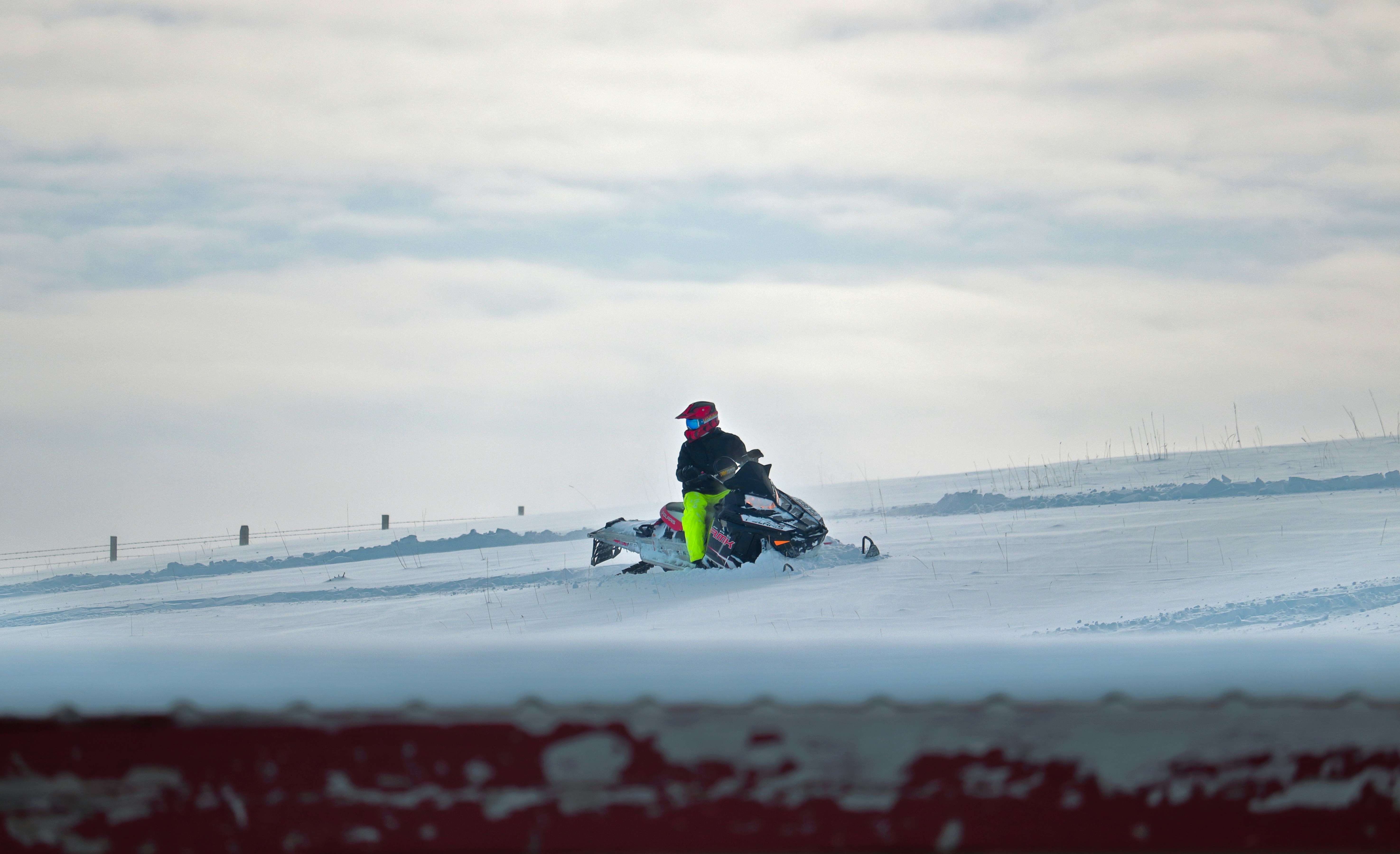 A man riding a snowmobile down a snow covered slope photo – Free Human ...