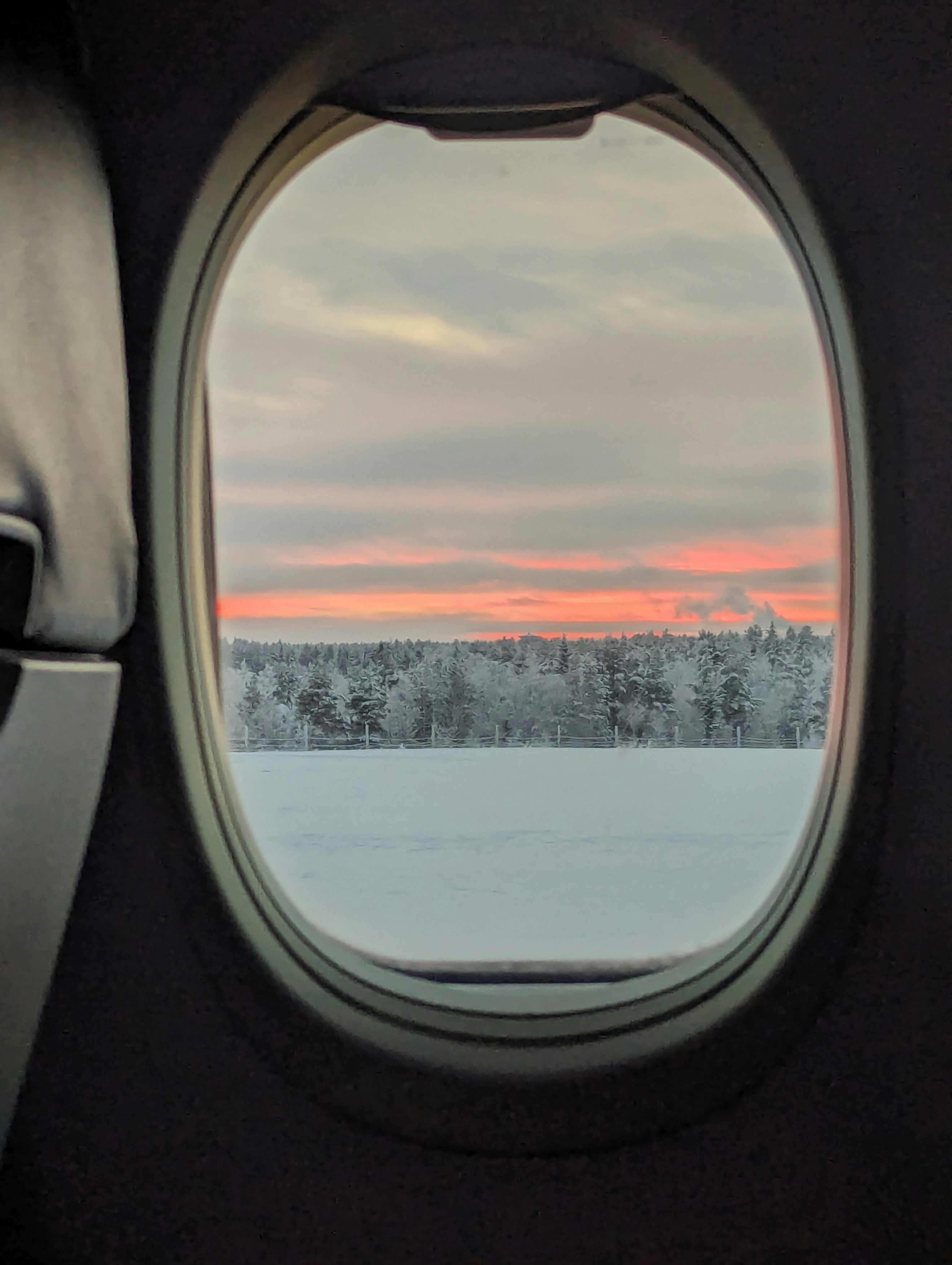 Horizon Fade: Sunset Over a Snowbound Landscape Framed by a Window