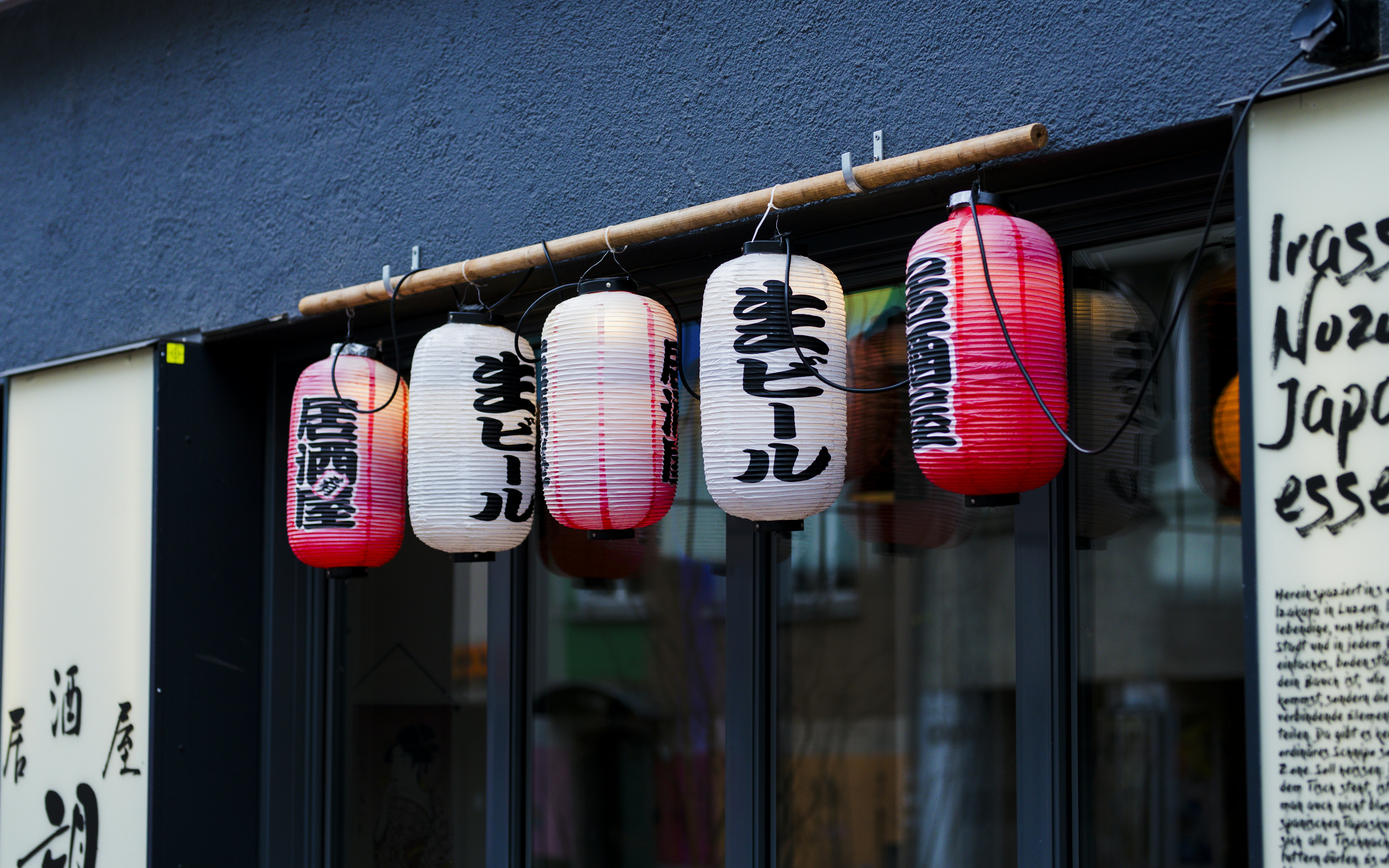 Row of Japanese Paper Lanterns Framing a Quiet Shopfront