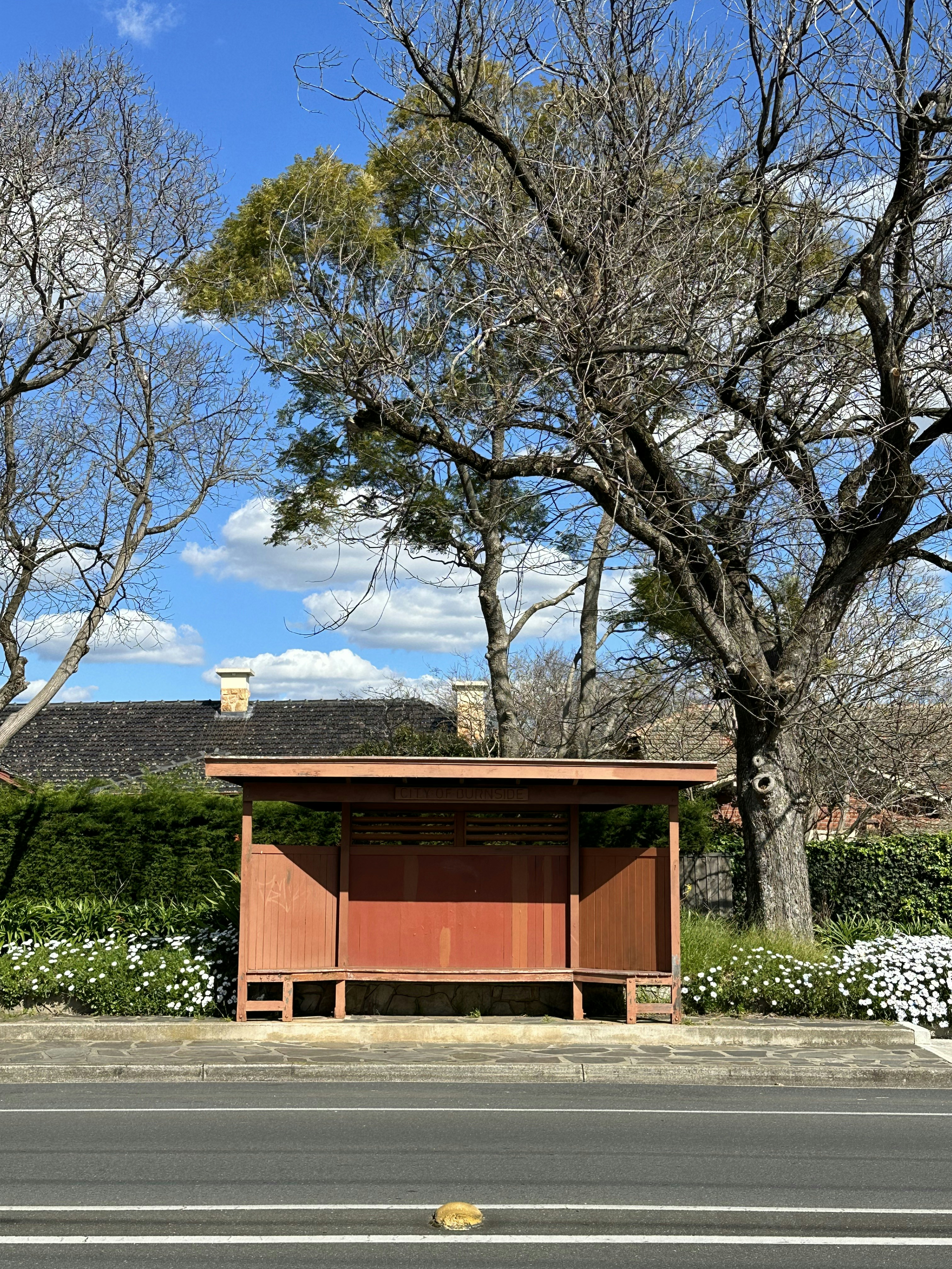 A small wooden structure sitting on the side of a road photo – Free Natural beauty Image on Unsplash