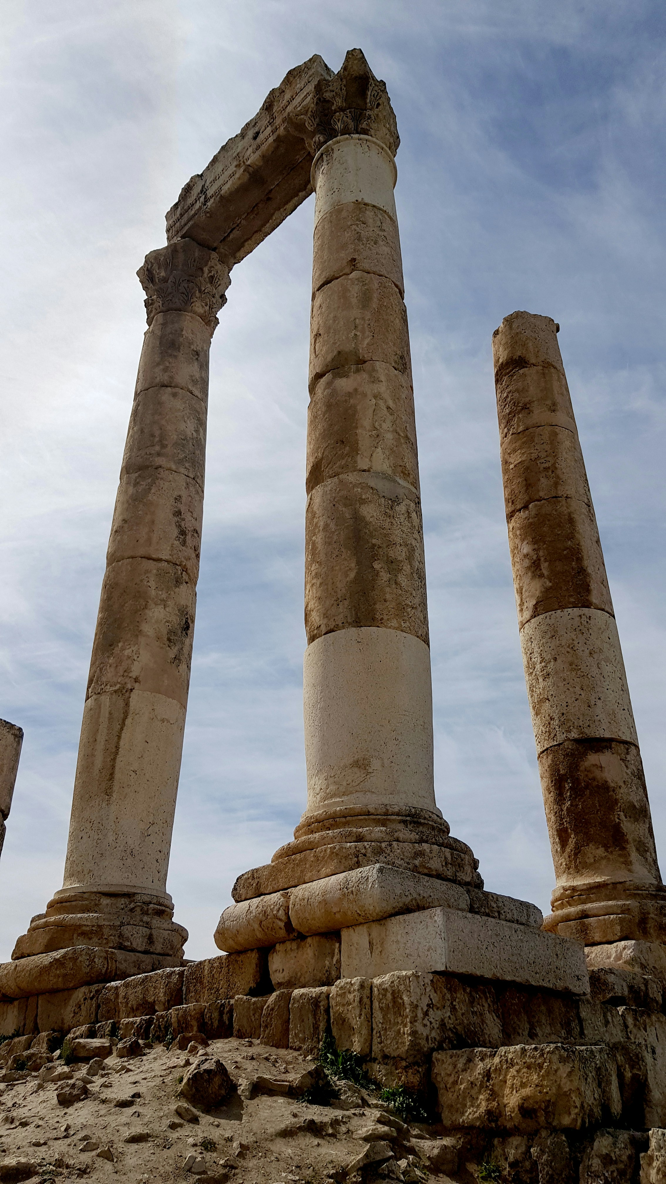 A couple of large stone pillars sitting on top of a dirt field photo ...