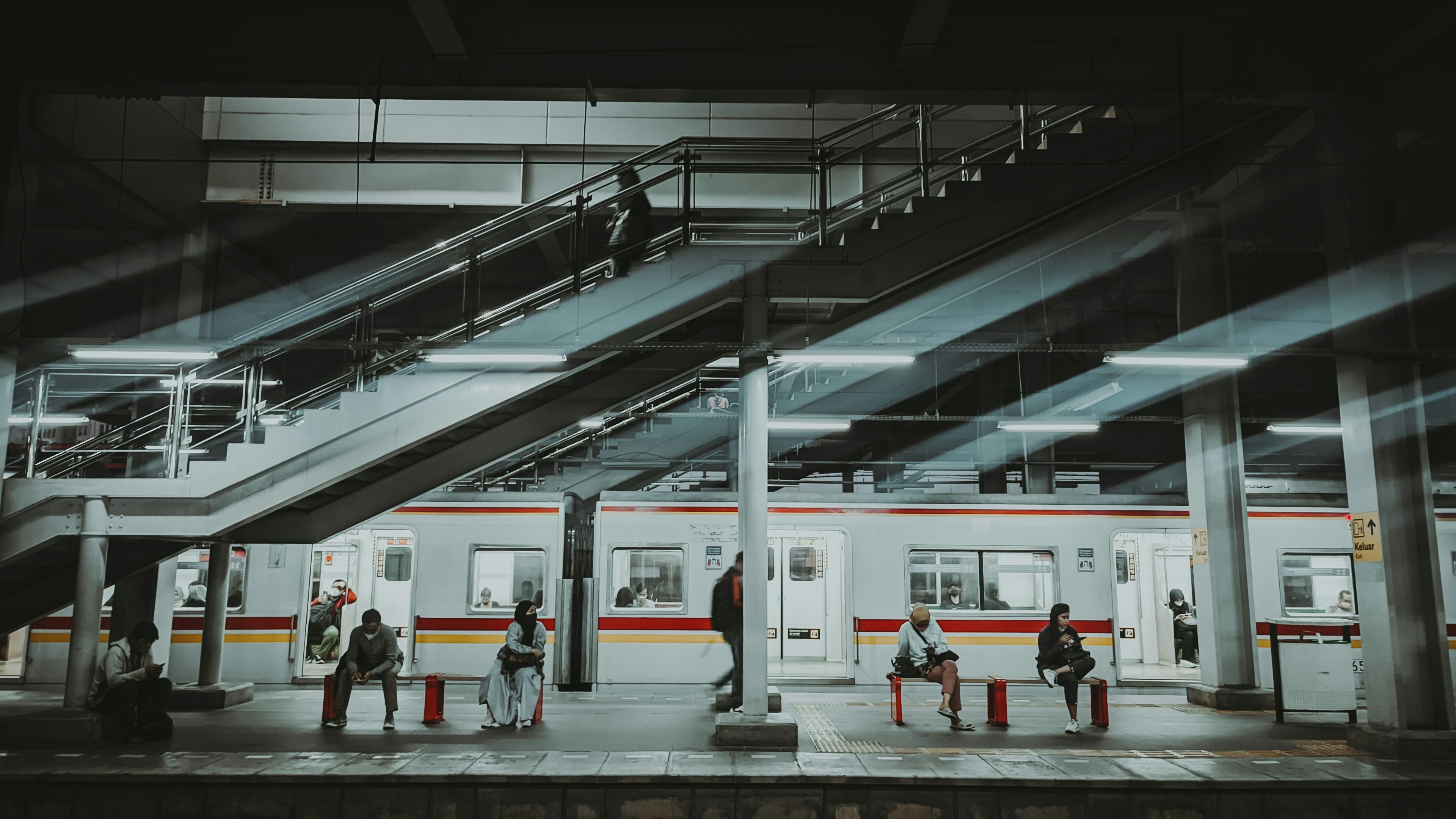 A group of people standing on a train platform photo – Free Grey Image ...