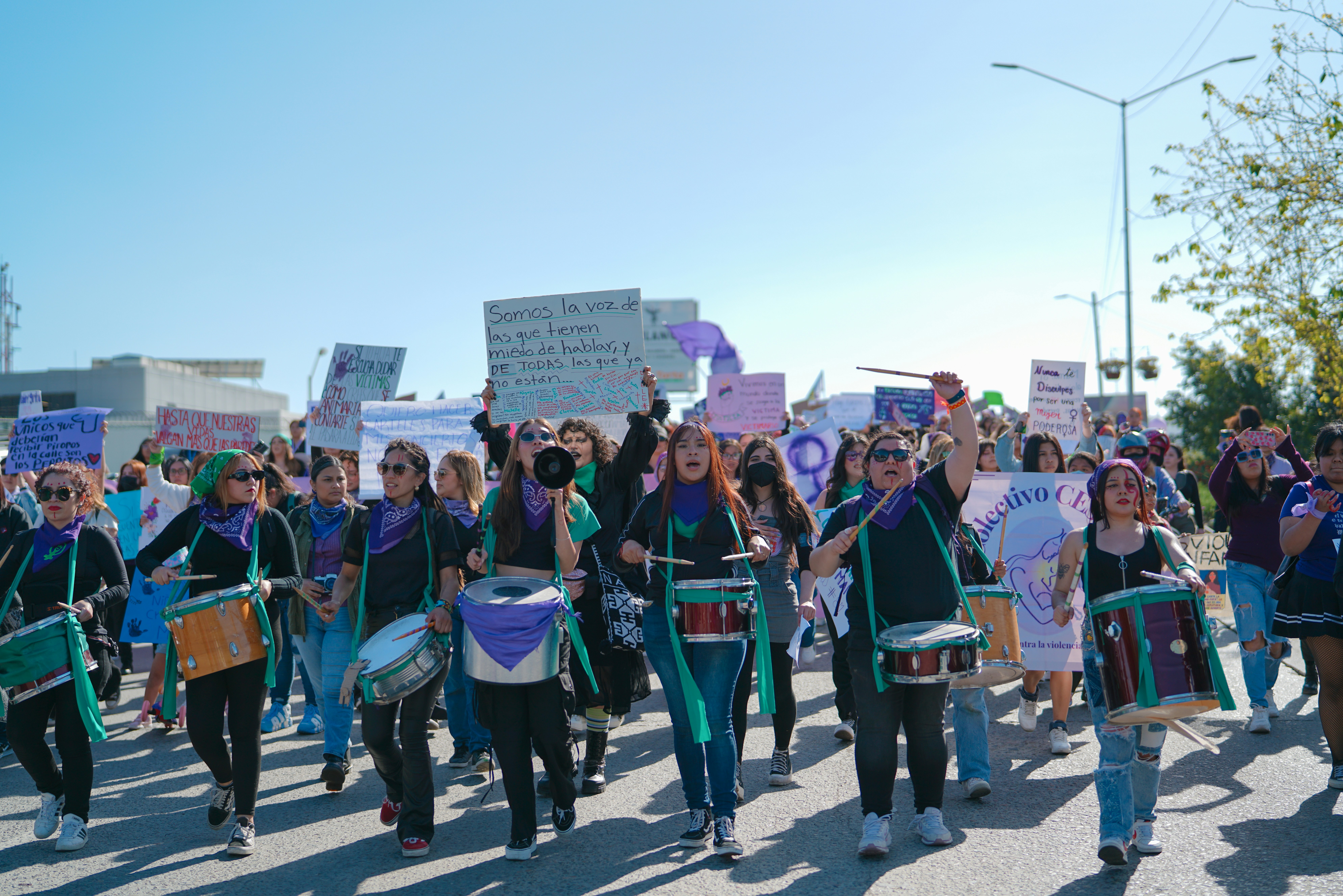 A group of people marching down a street photo – Free People Image on ...