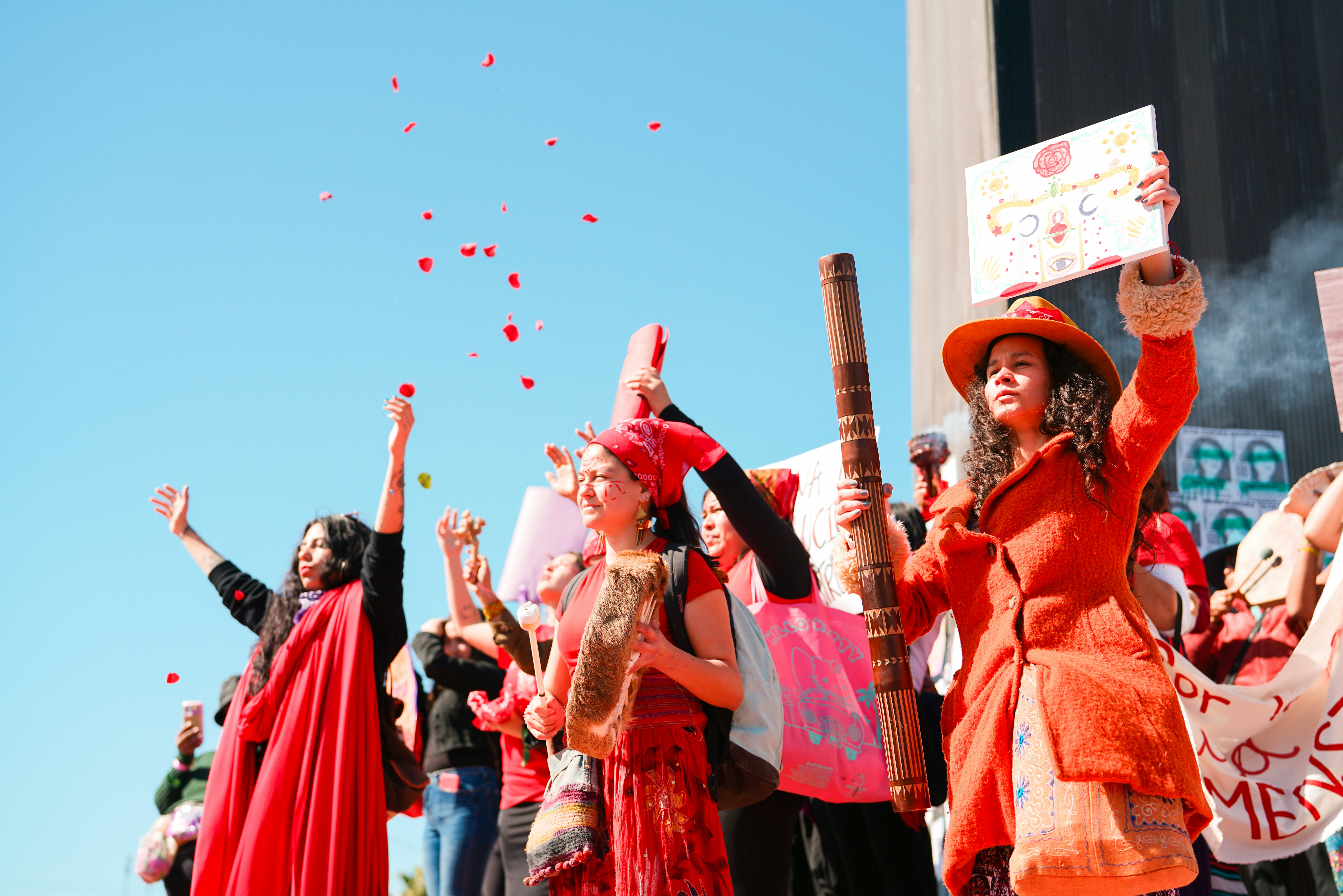 Scarlet Parade: Confetti, Hats, and a Sign of Joy