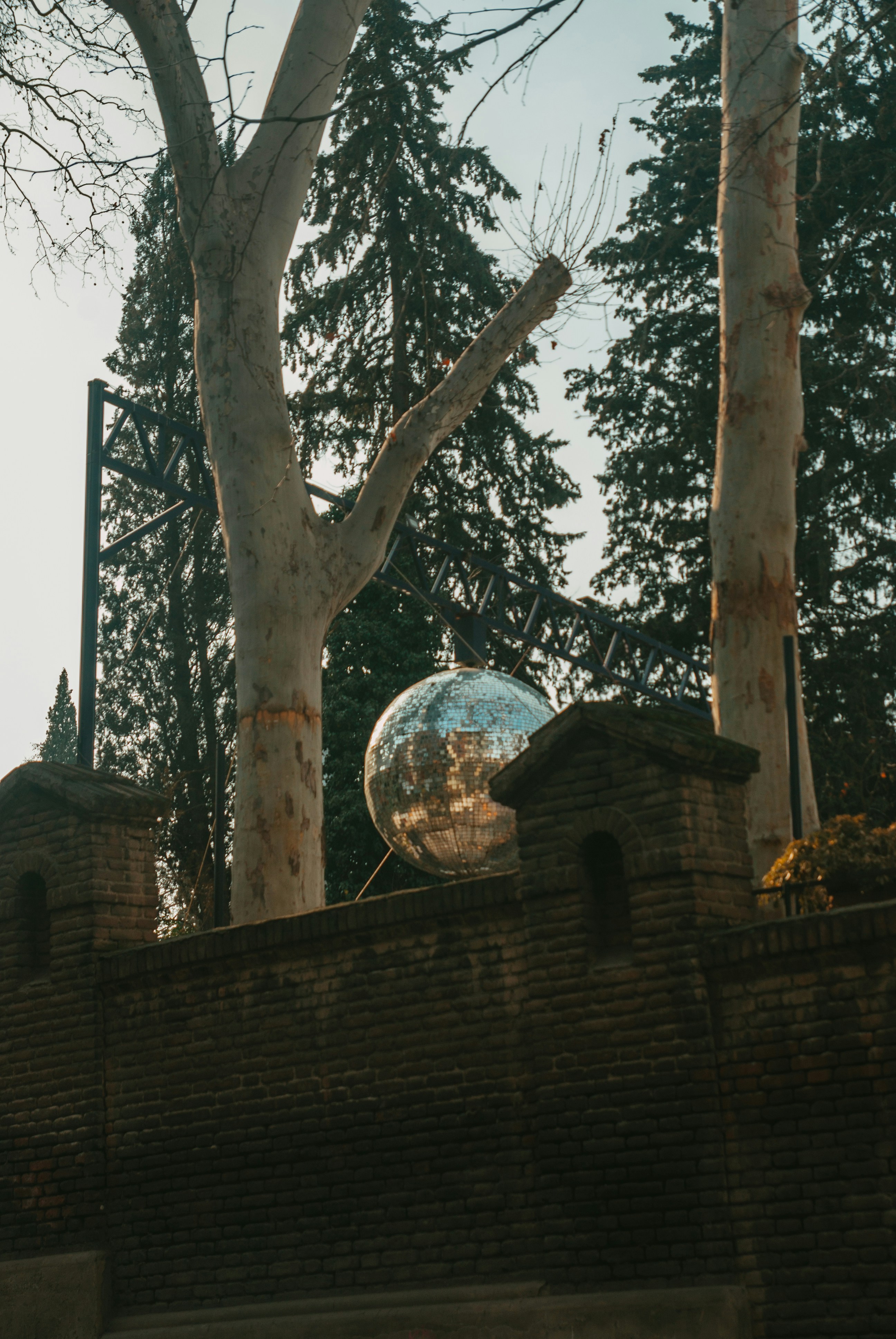 a large crystal ball sitting on top of a brick wall