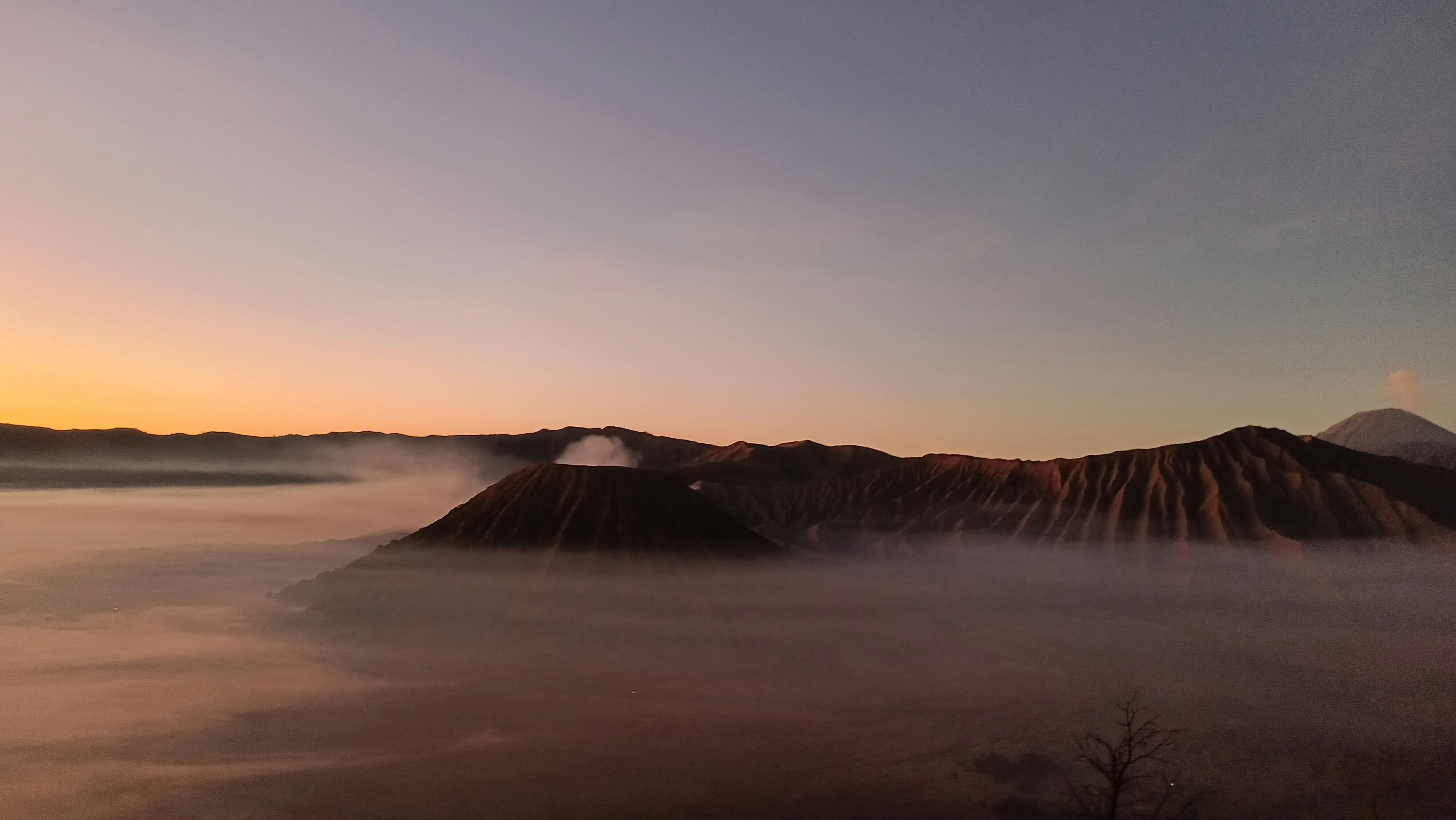 A view of a mountain covered in fog photo – Free Bromo mountain Image ...
