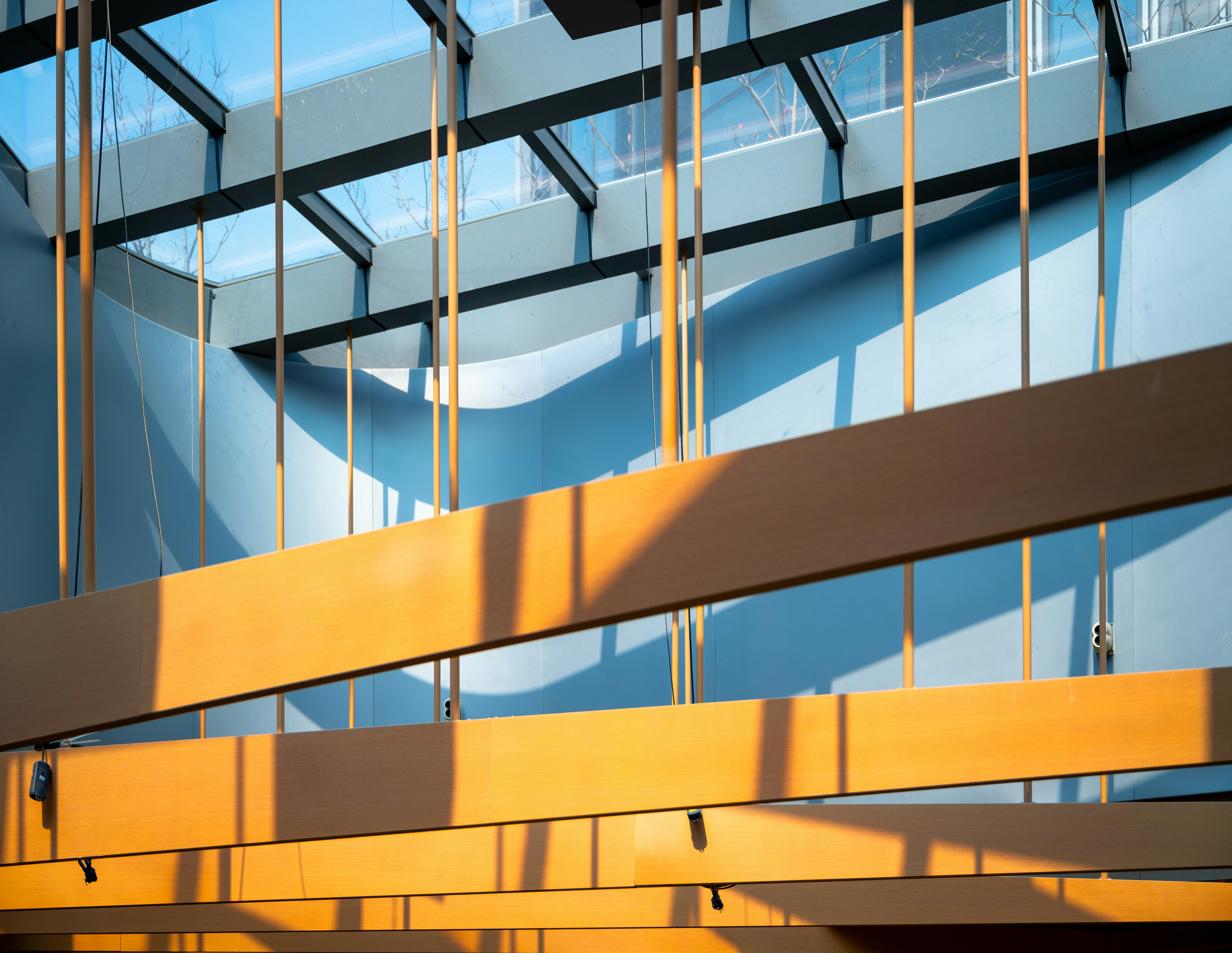 Sunlit Orange Beams: A Geometric Play of Shadows and Steel