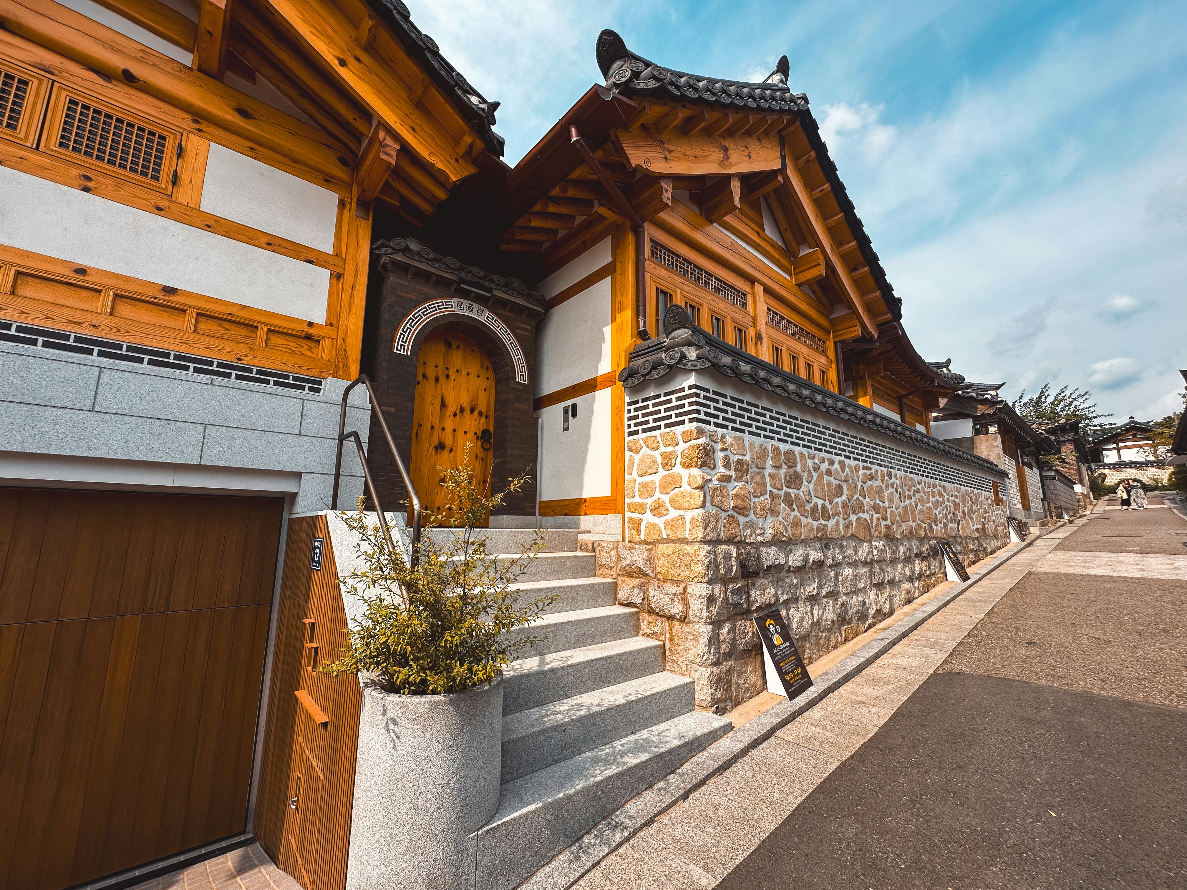 A stone and wood building with stairs leading up to it photo – Free ...