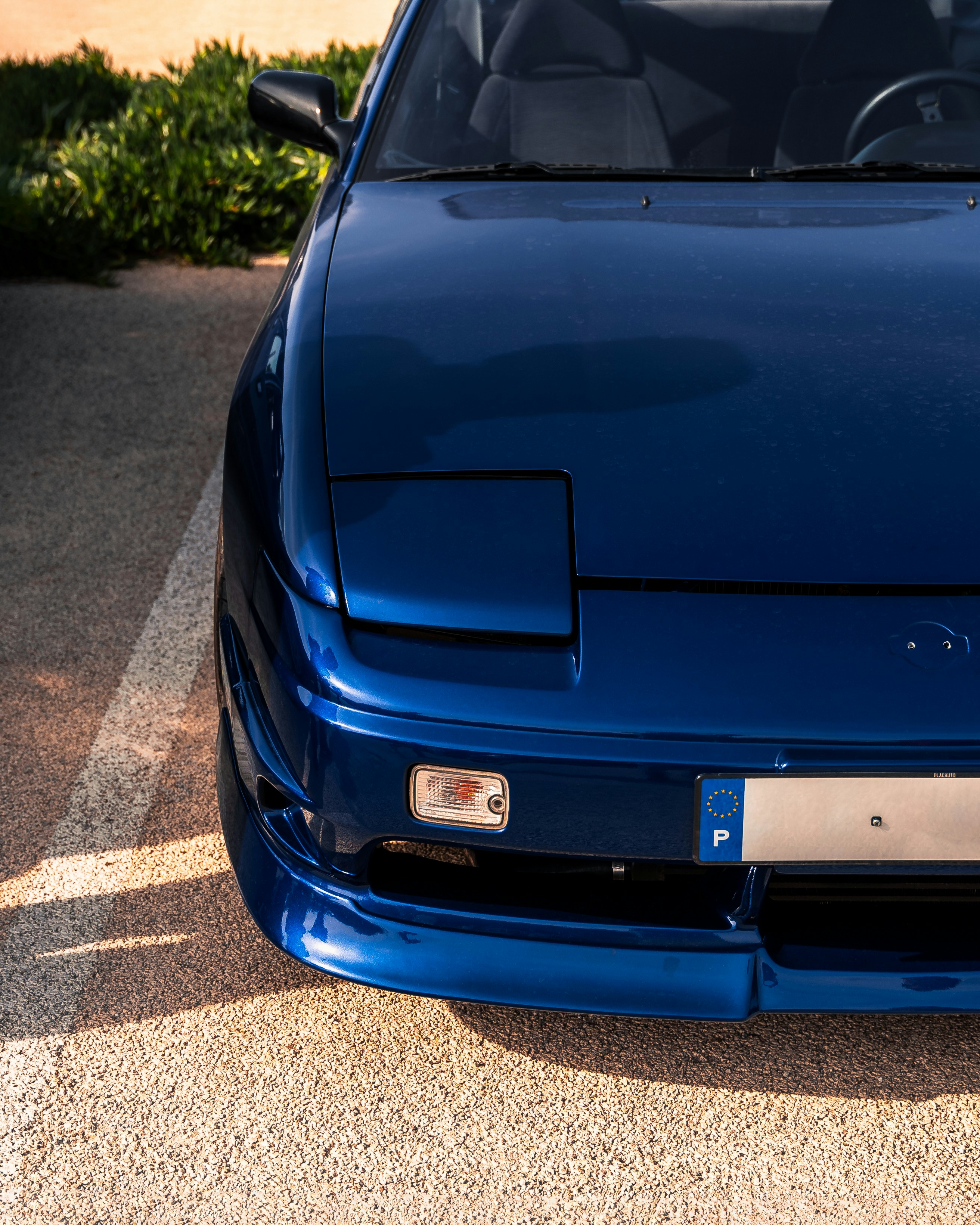 Azure Front-Quarter Gleam in a Sunlit Parking Lot