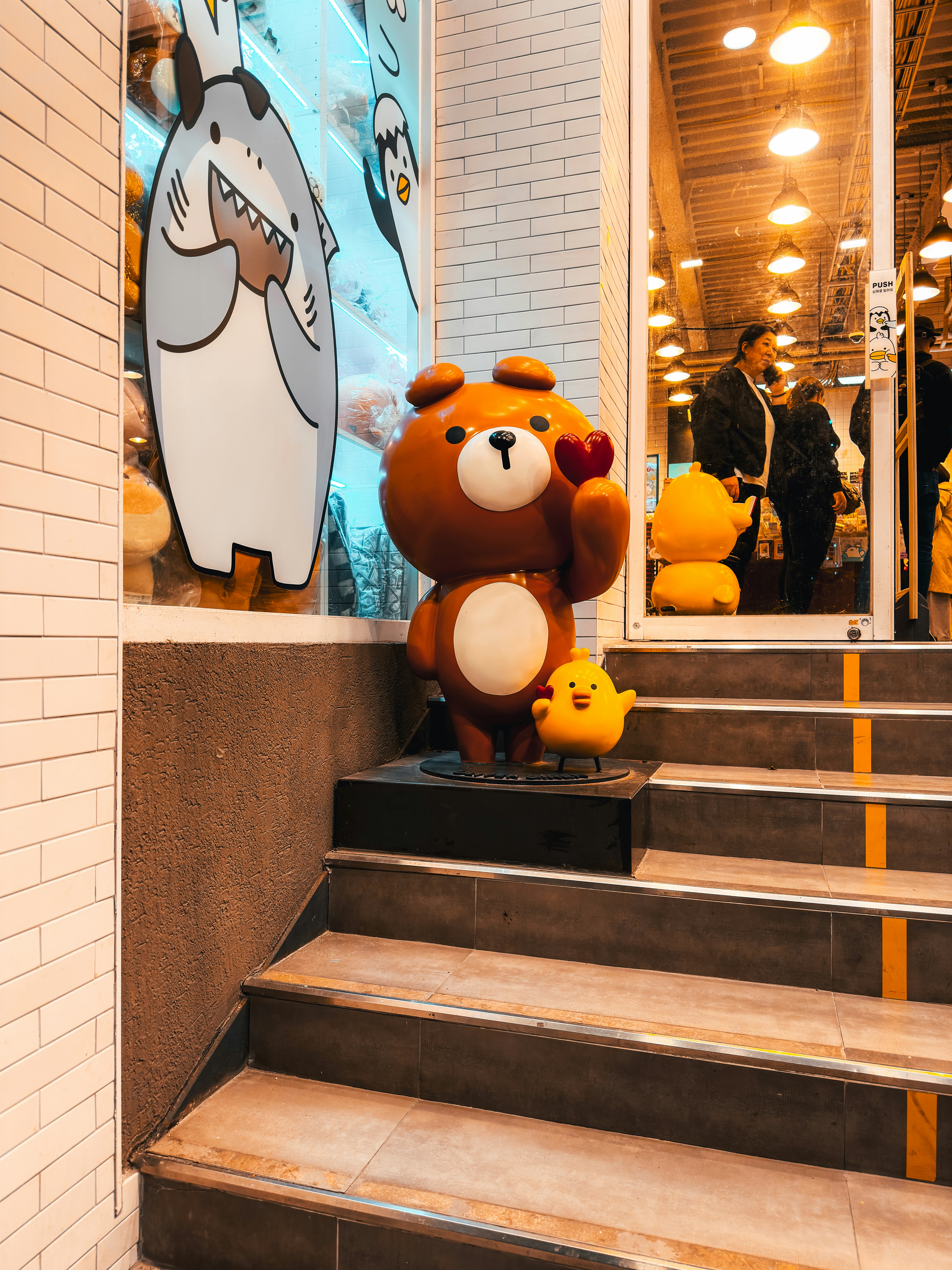 A teddy bear sitting on top of a set of stairs photo – Free Man Image ...