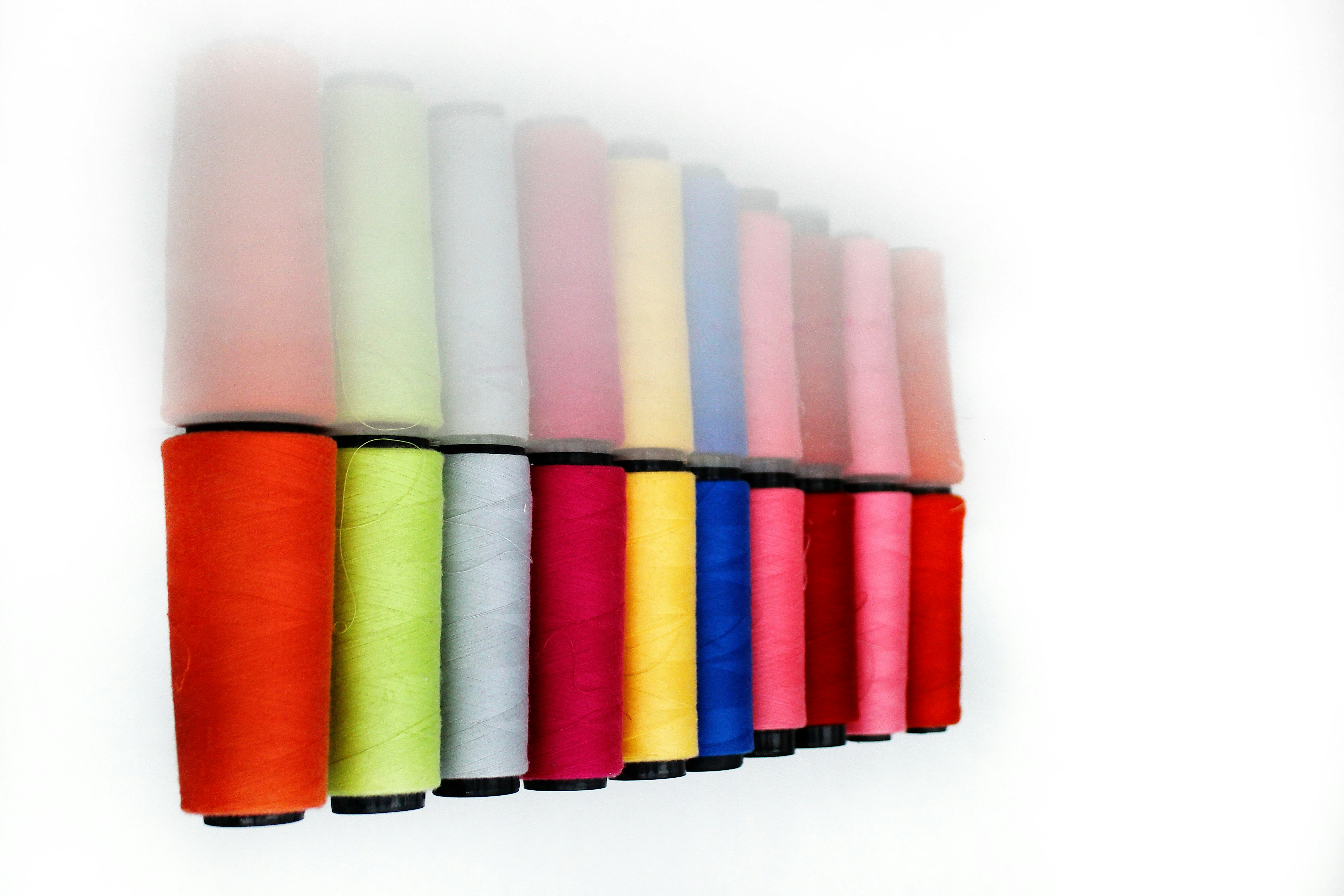 A bunch of spools of thread hanging on a wall photo – Free Editorial ...