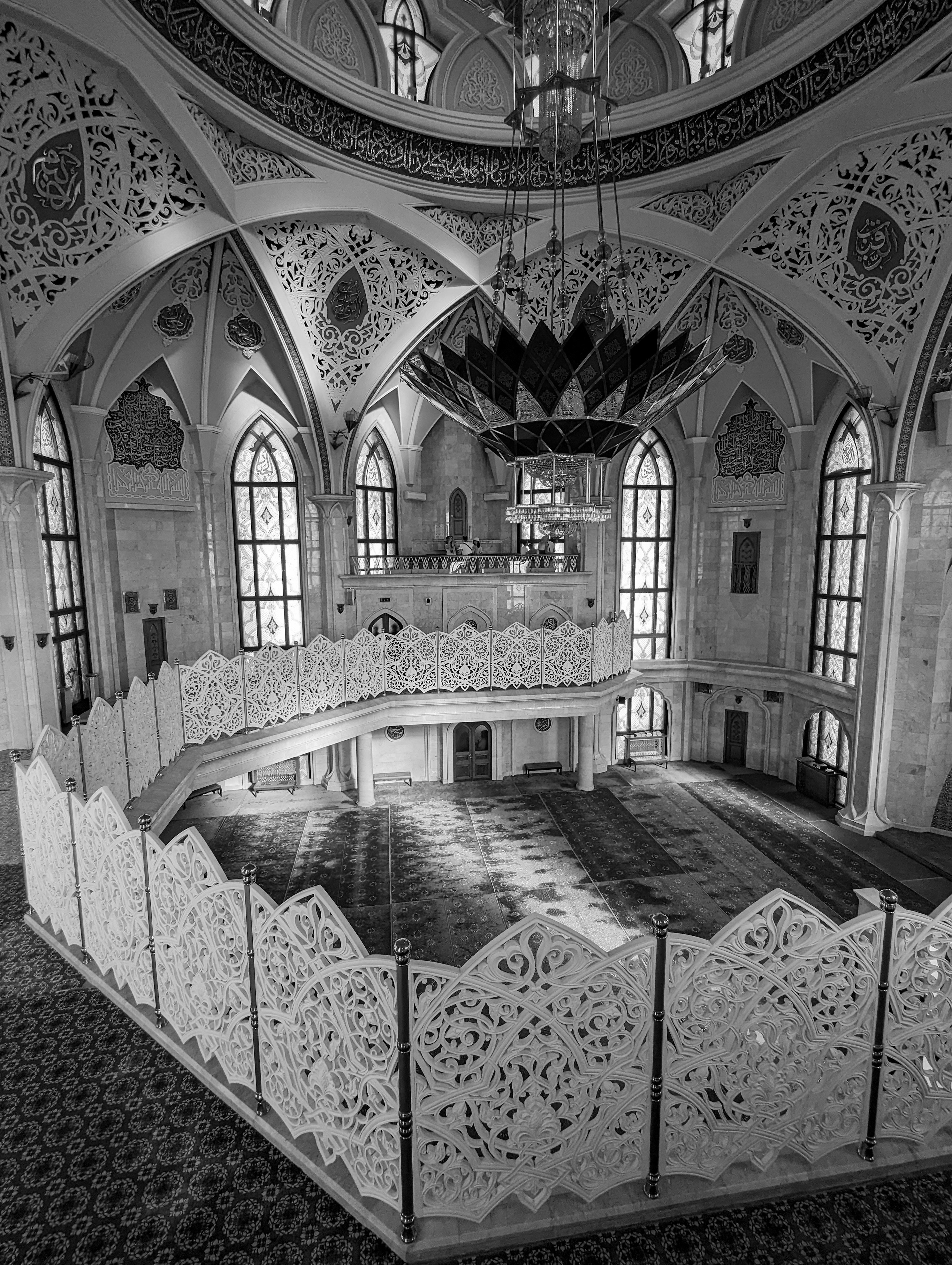 Monochrome Cathedral: Lace Railings Framing a Grand Chandelier