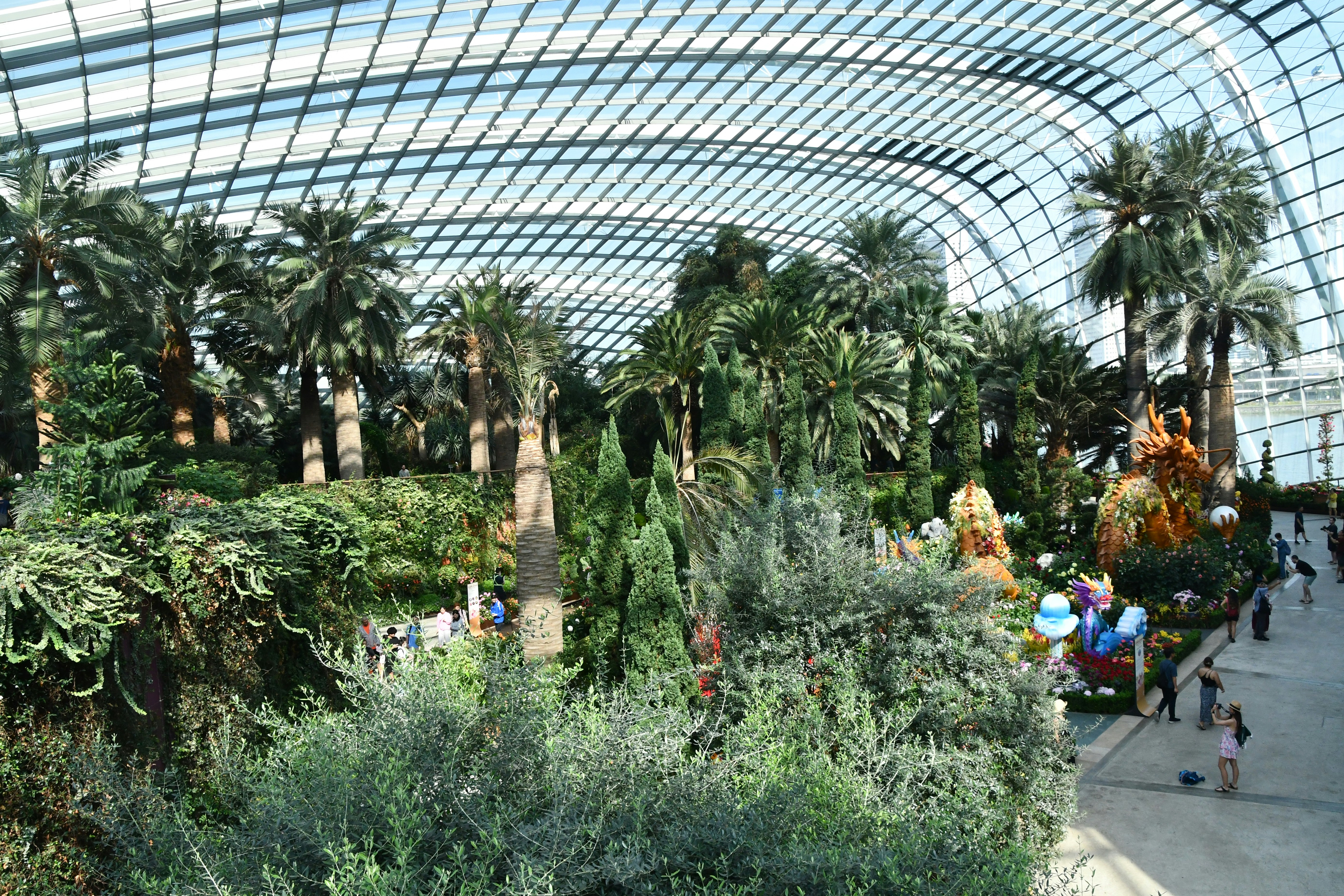 A group of people walking around inside of a building photo – Free ...