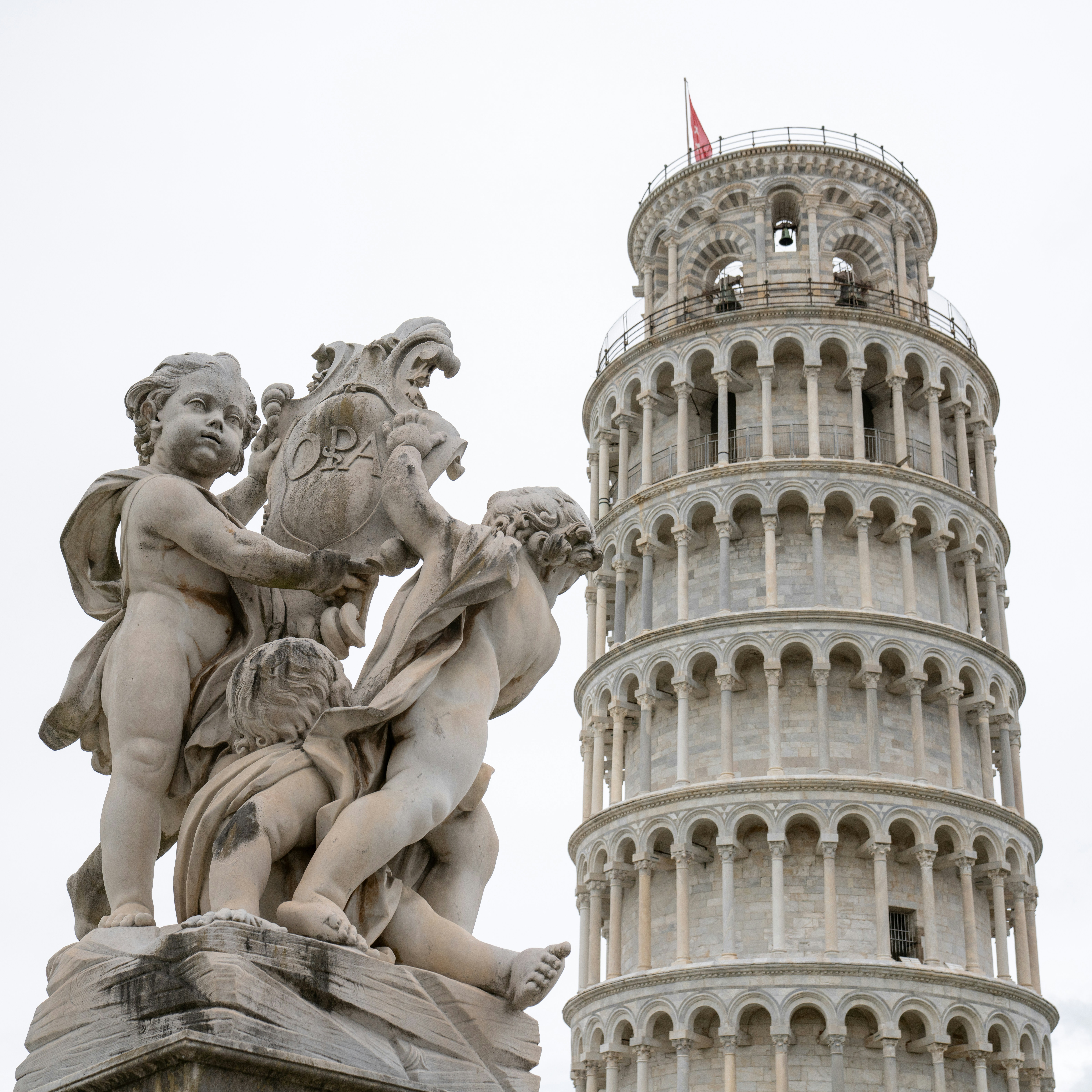 Marble Cherubs Guard Pisa: The Leaning Tower in a Quiet Portrait