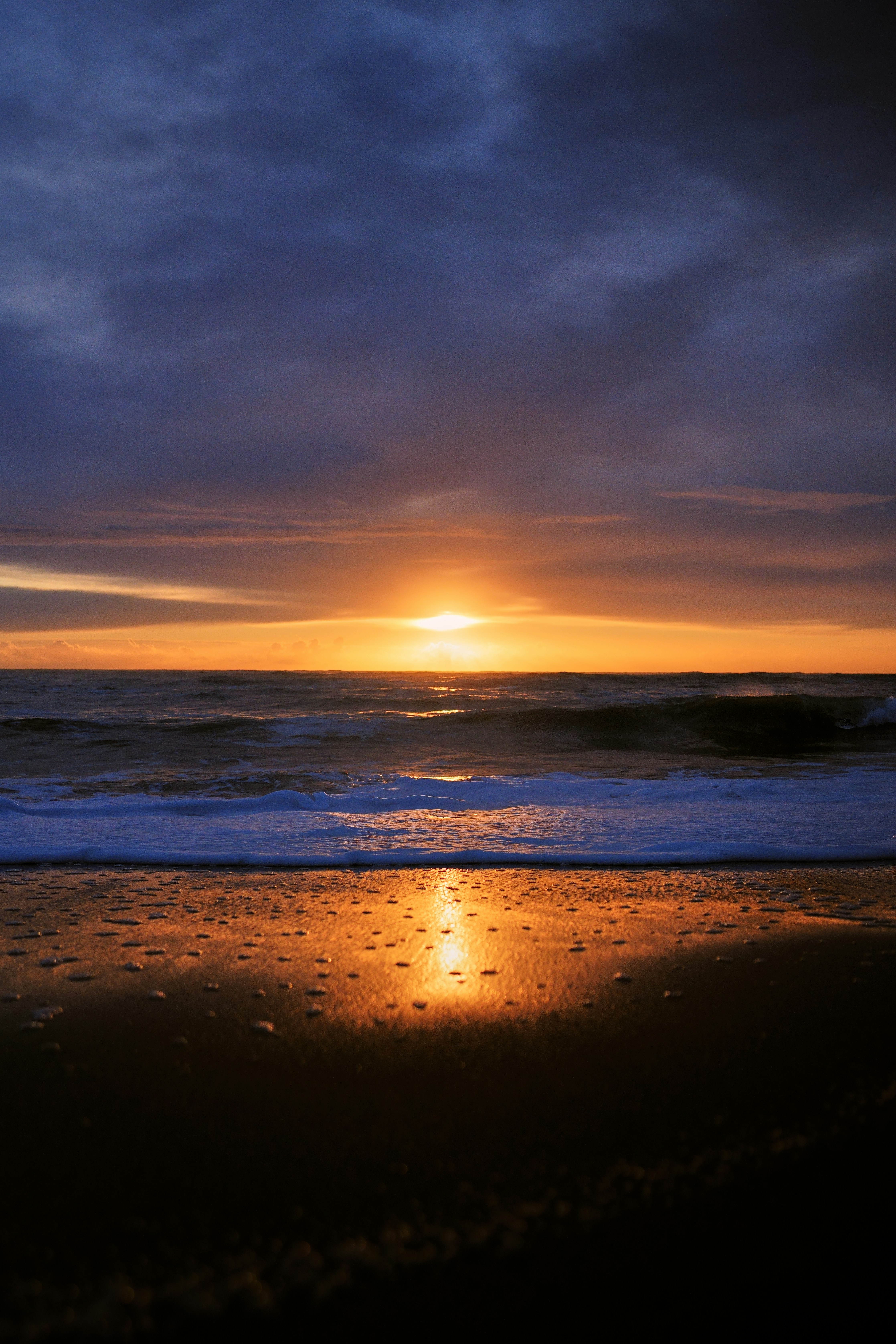 The sun is setting over the ocean on the beach photo – Free ...