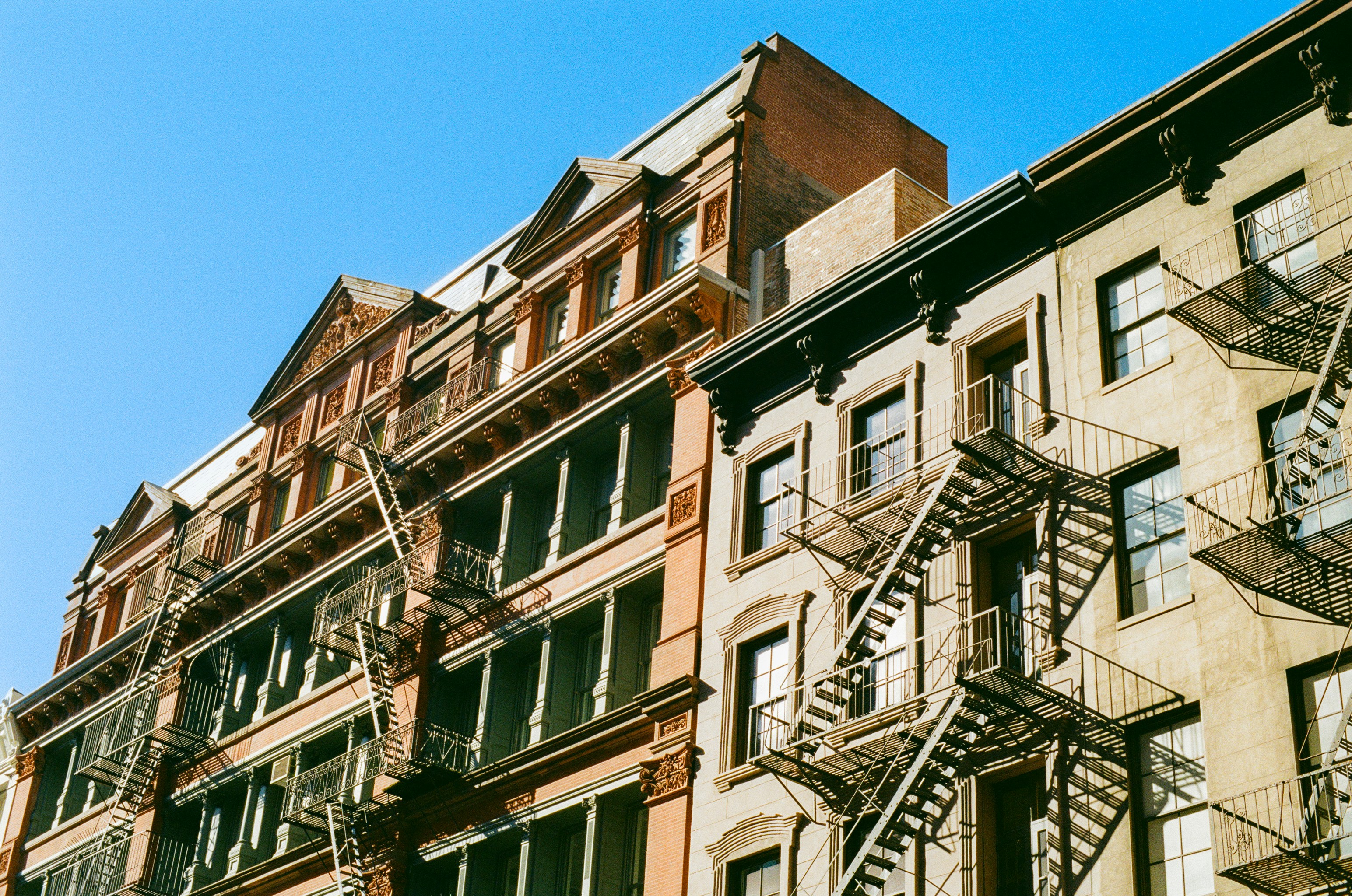 A building with a fire escape next to it photo – Free Building Image on ...