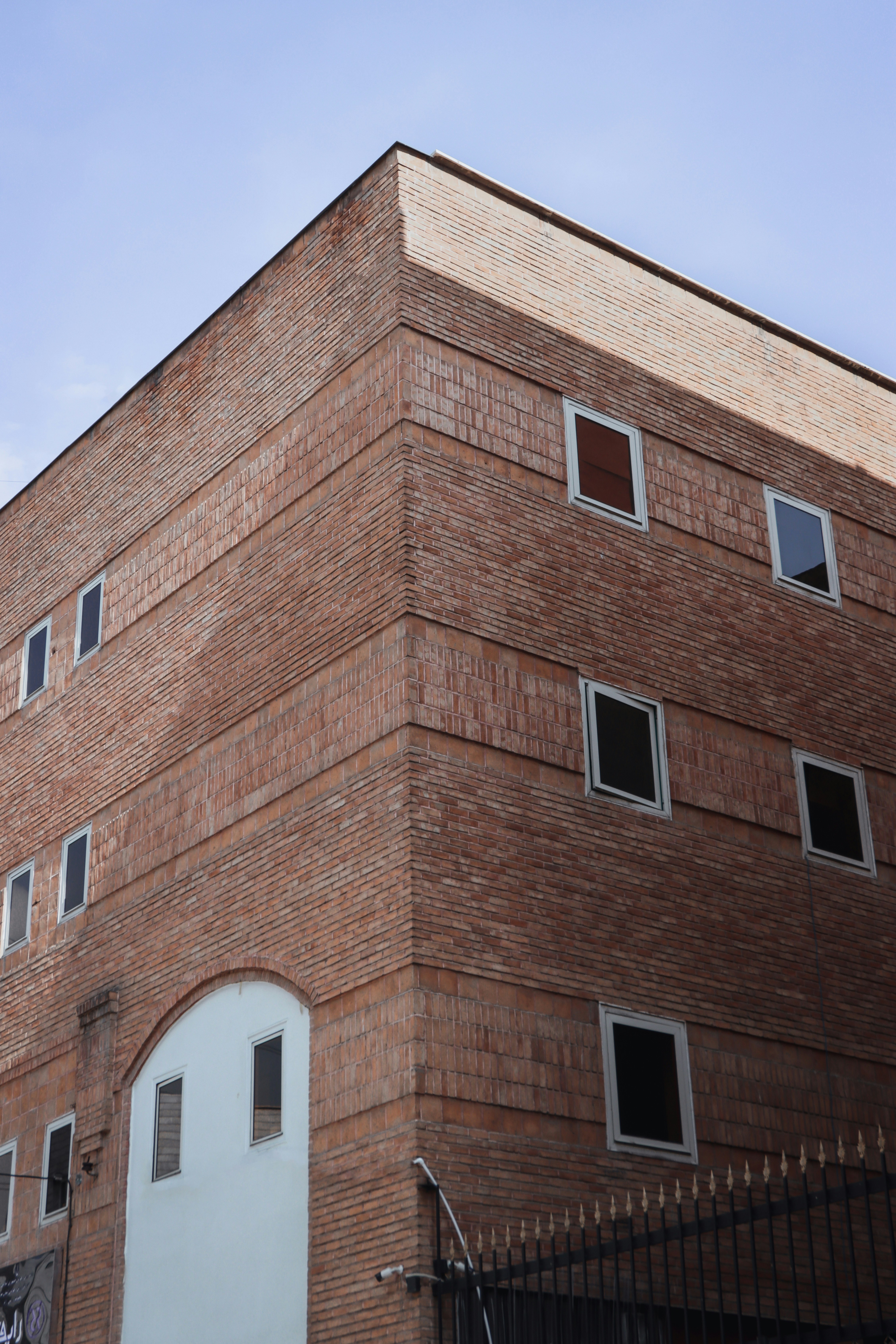 A tall brick building with lots of windows photo – Free Tehran province ...
