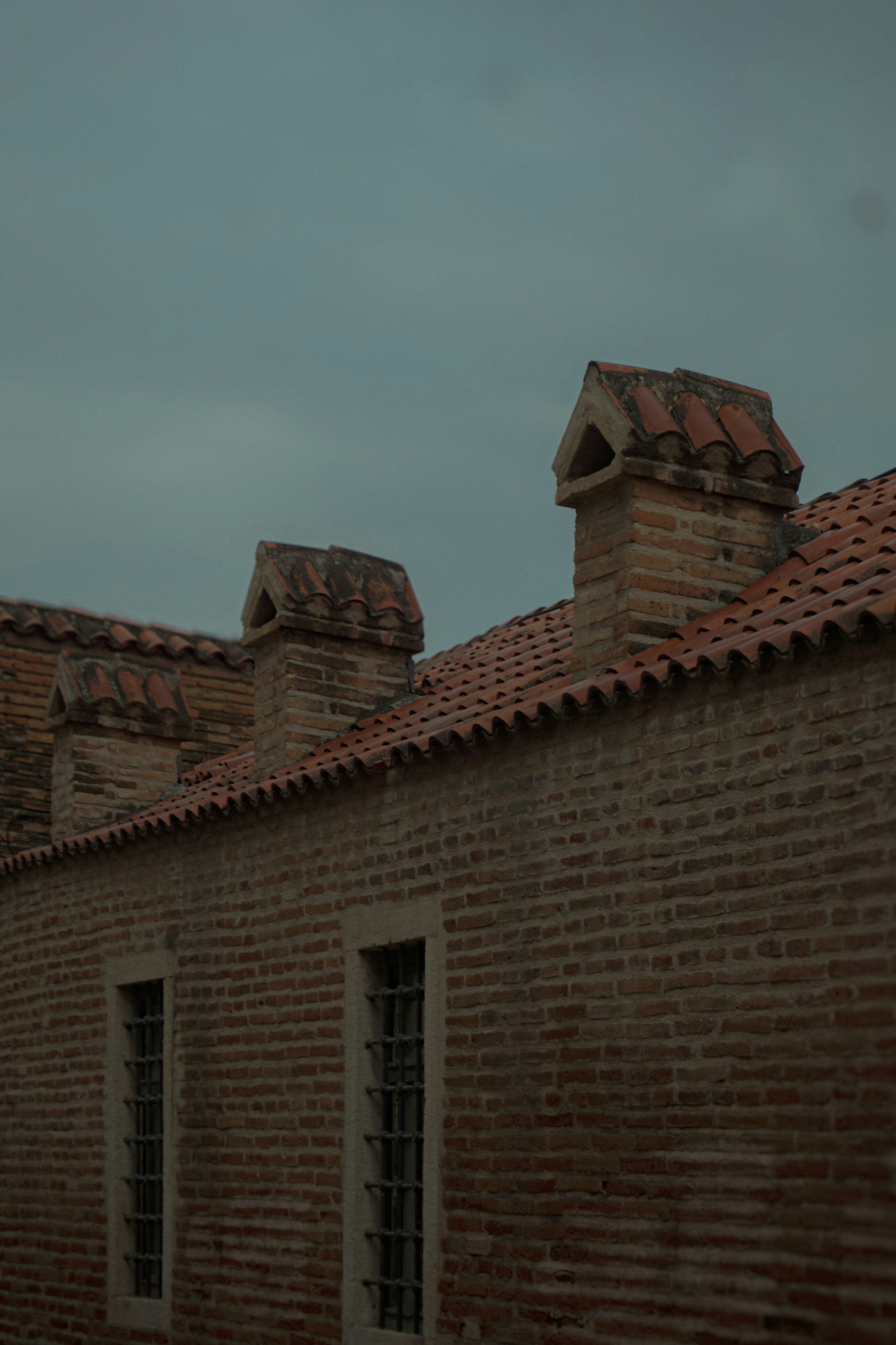 Chimneys and Tile: a Quiet Roofscape under a Moody Sky