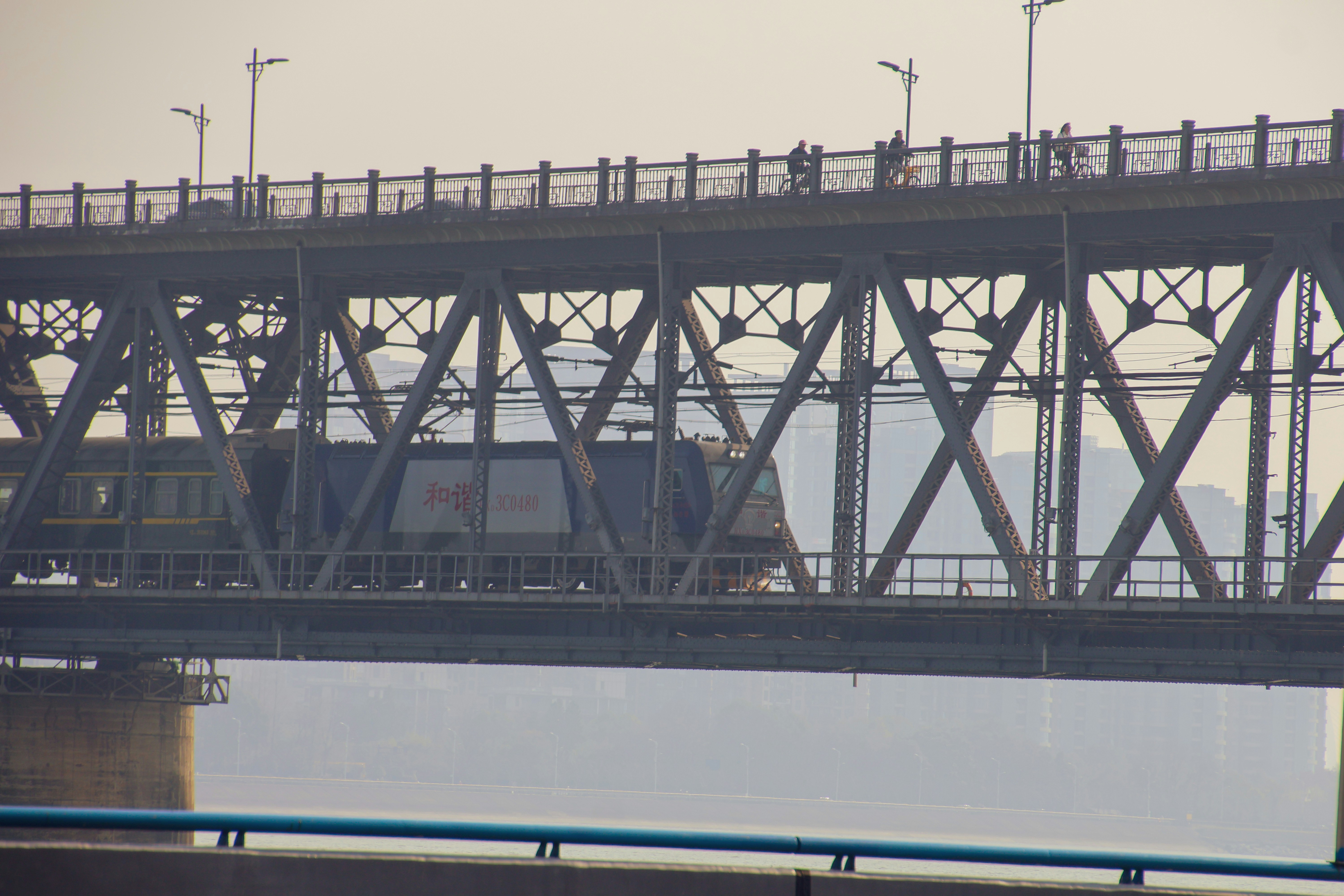 Over Iron Lattice: Freight Train Crossing a Weathered Truss Bridge