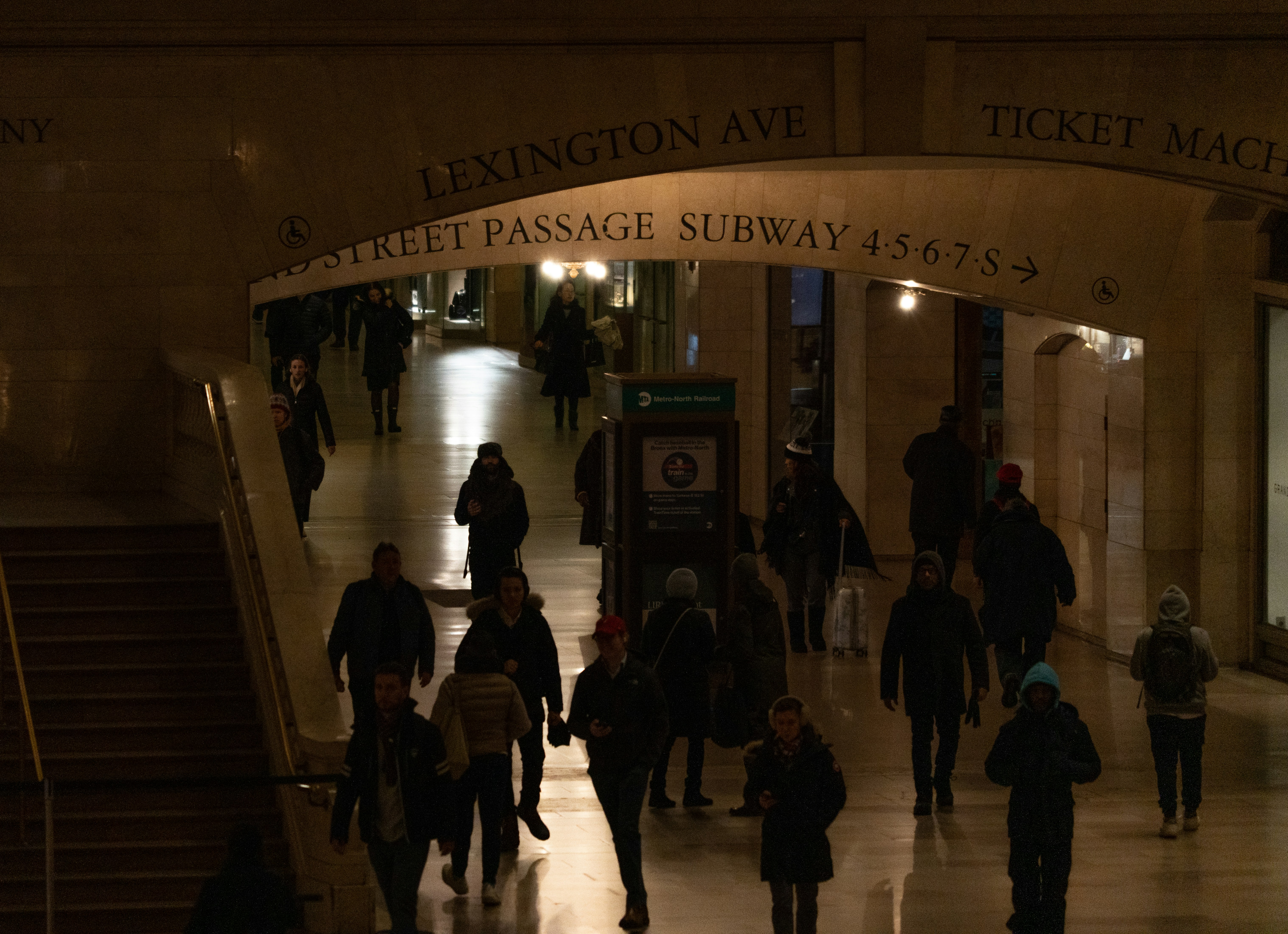 A group of people walking down a hallway photo – Free Grand central ...