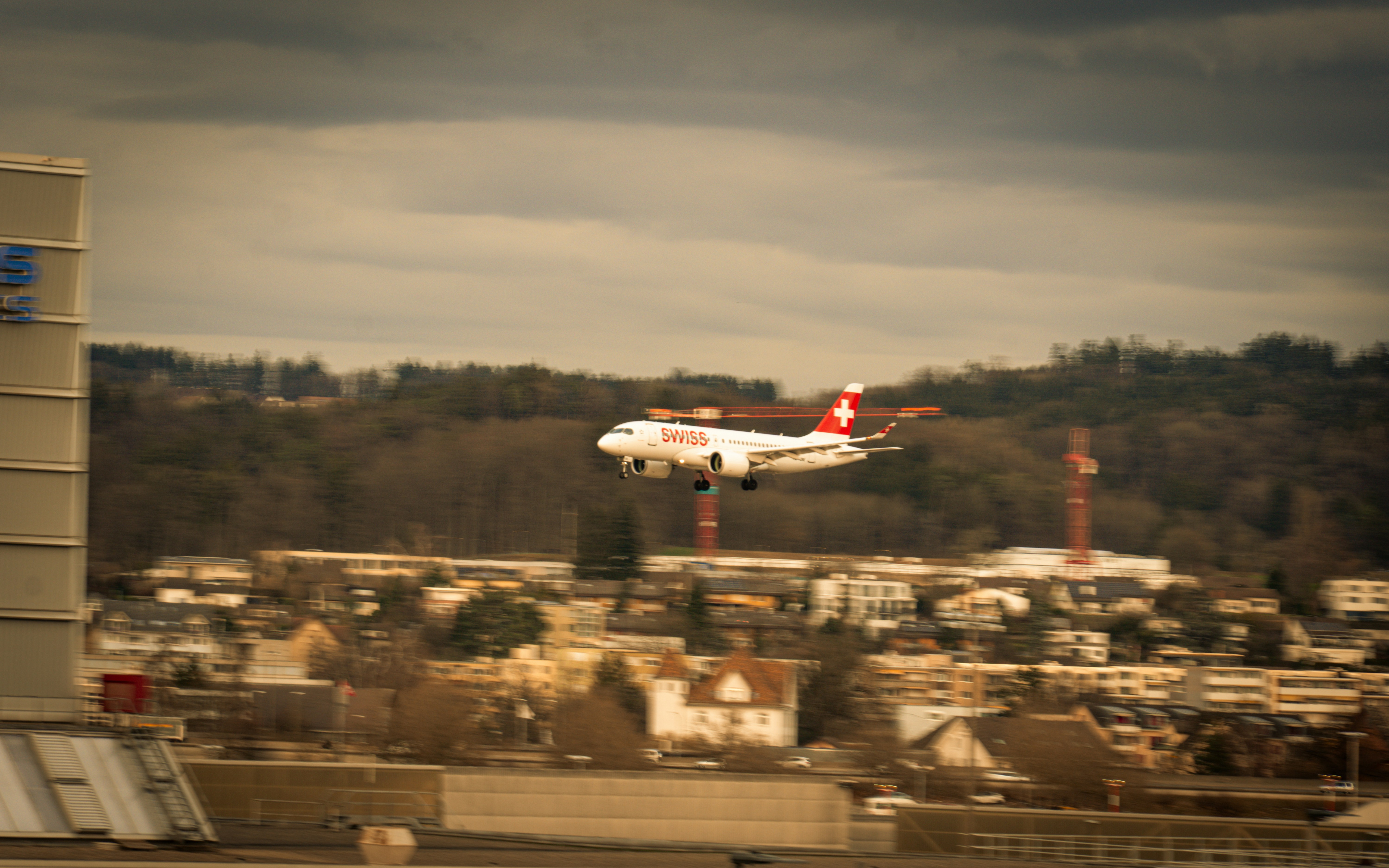 Crossing Sky: Swiss A320 Glides Above a Quiet Town