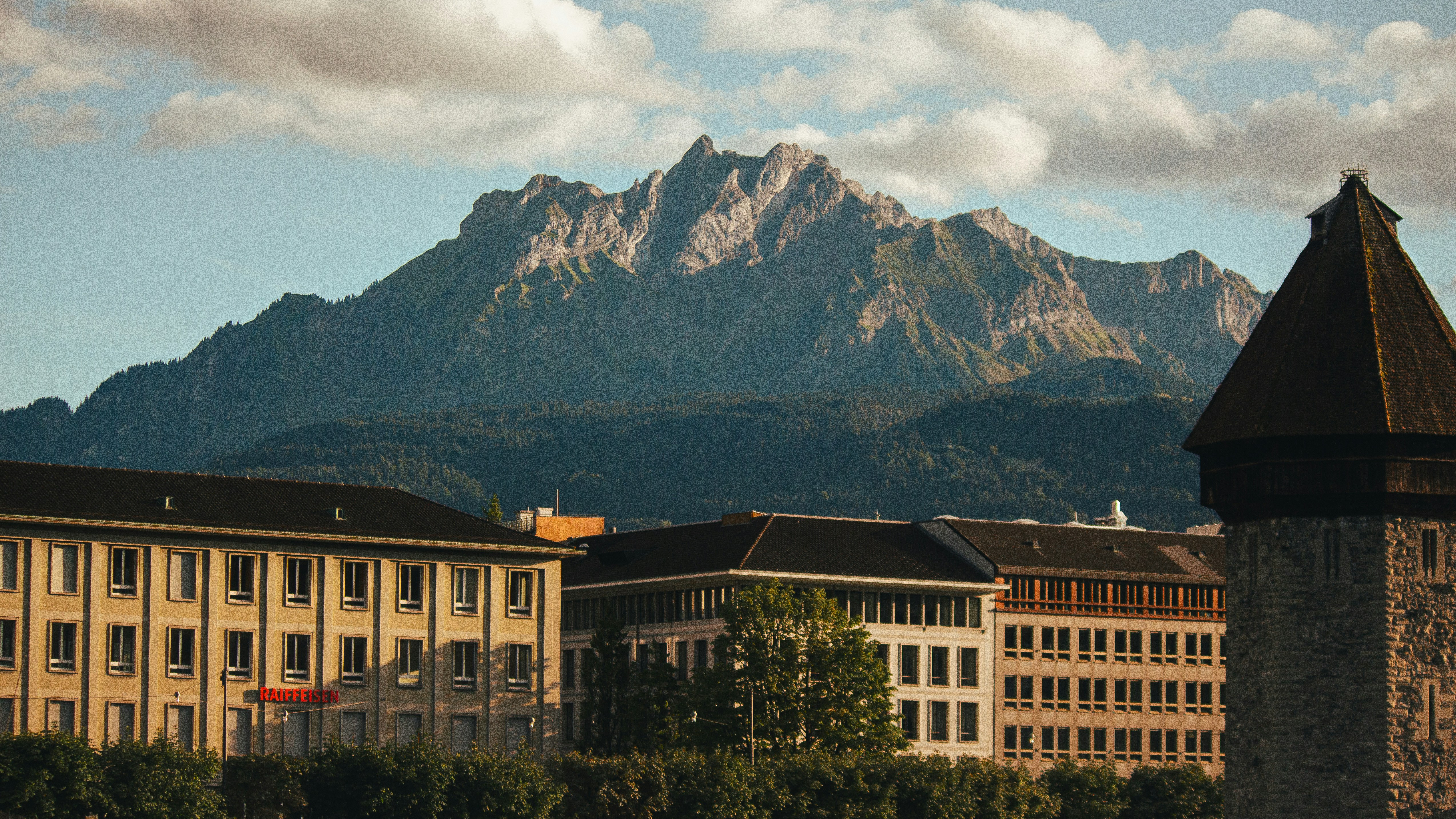 A view of a building with a mountain in the background photo – Free ...