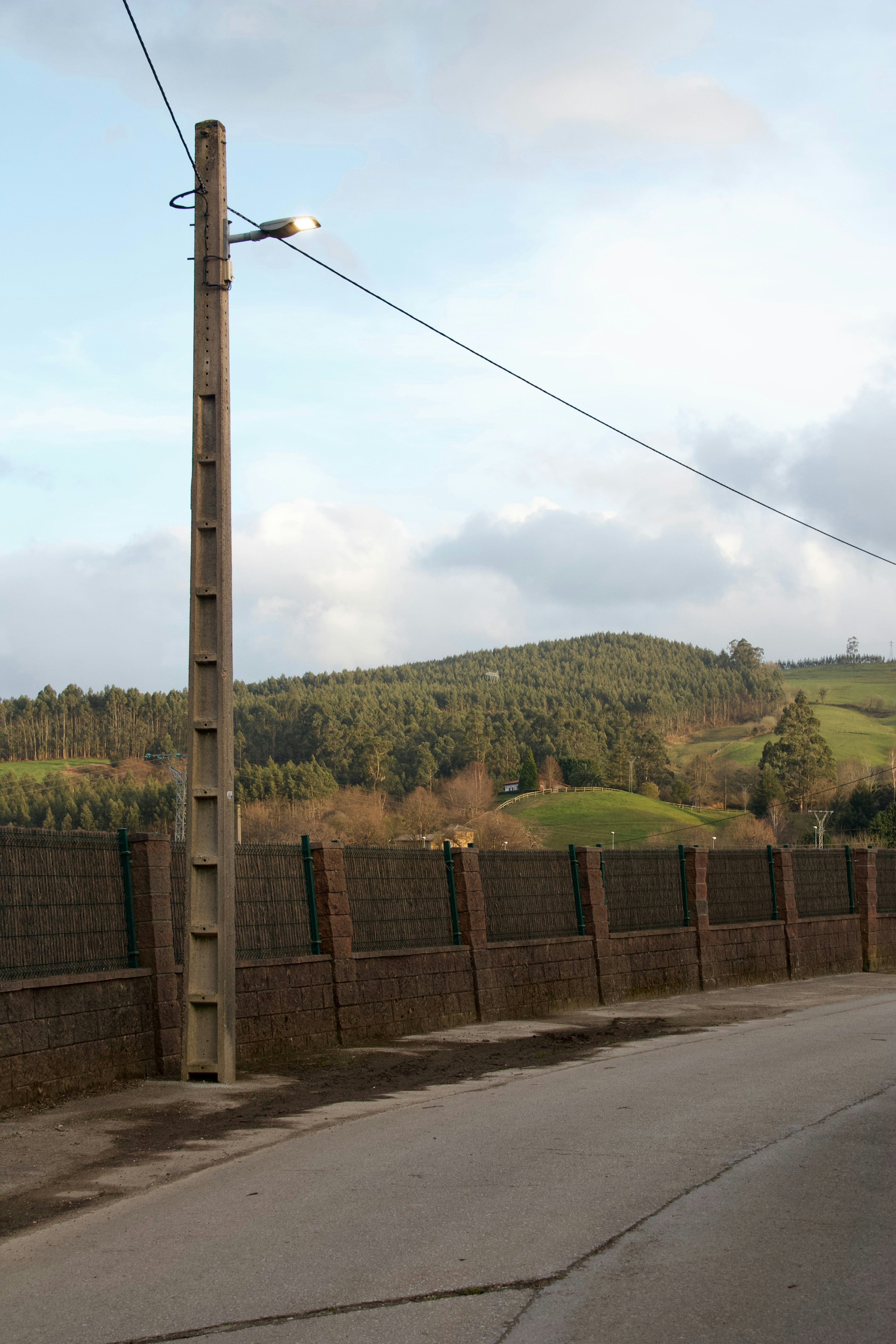 A tall wooden pole next to a road photo – Free Utility pole Image on ...