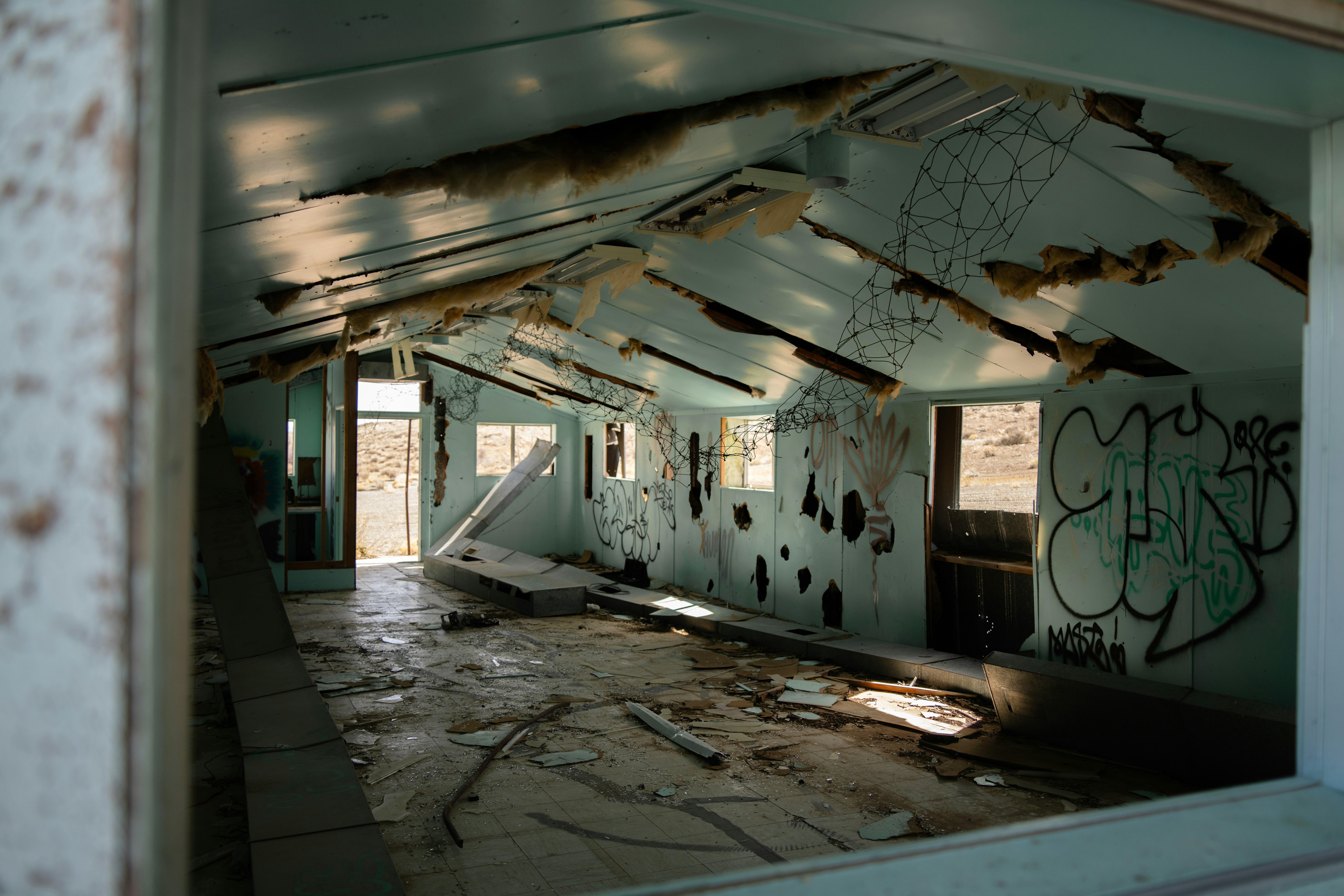 A run down building with graffiti on the walls photo – Free Building ...