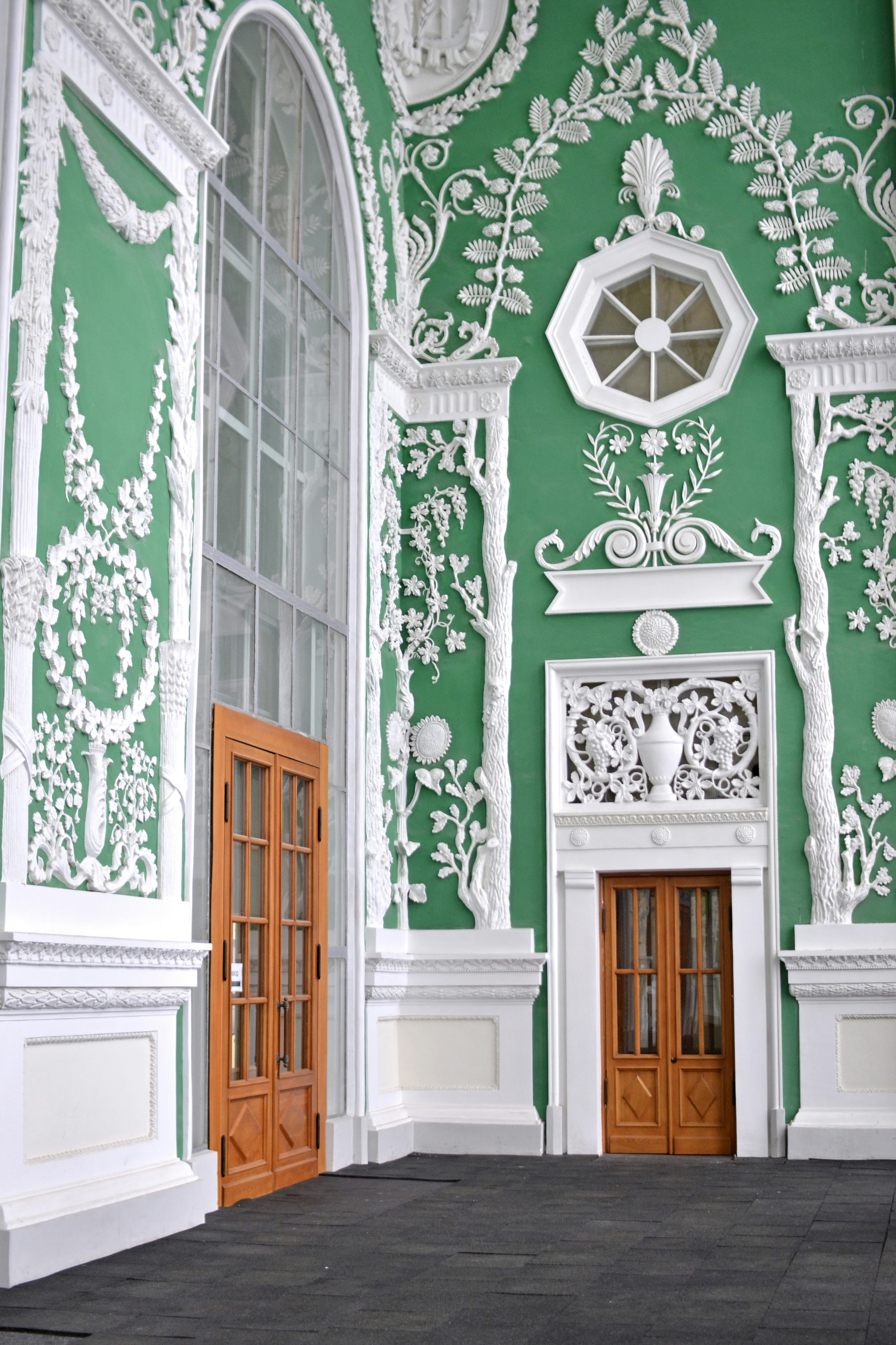 Verdant Baroque: White Florals Framing a Green Facade