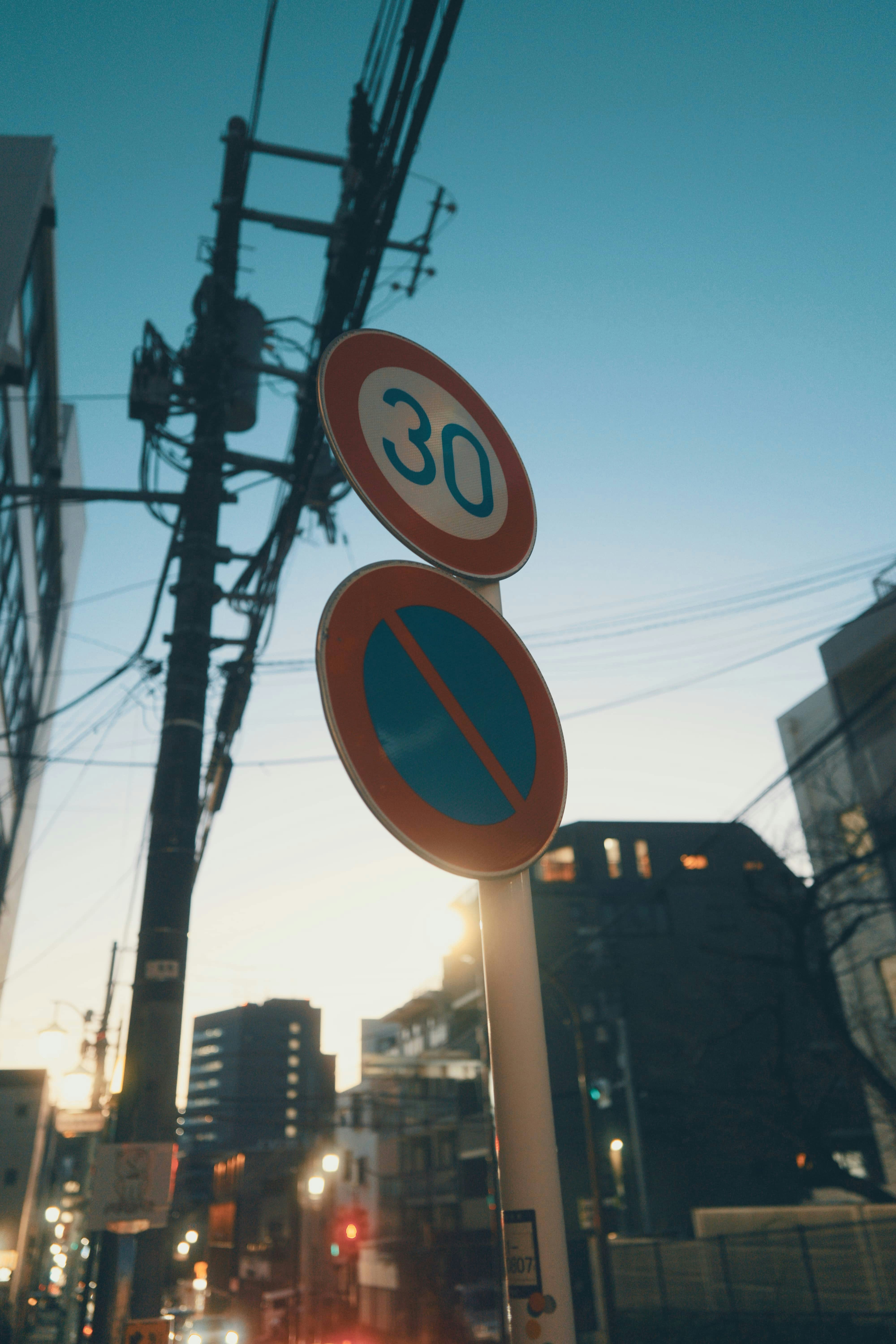 Leaned Circles at Dusk: A Street-Side Portrait of Urban Signals