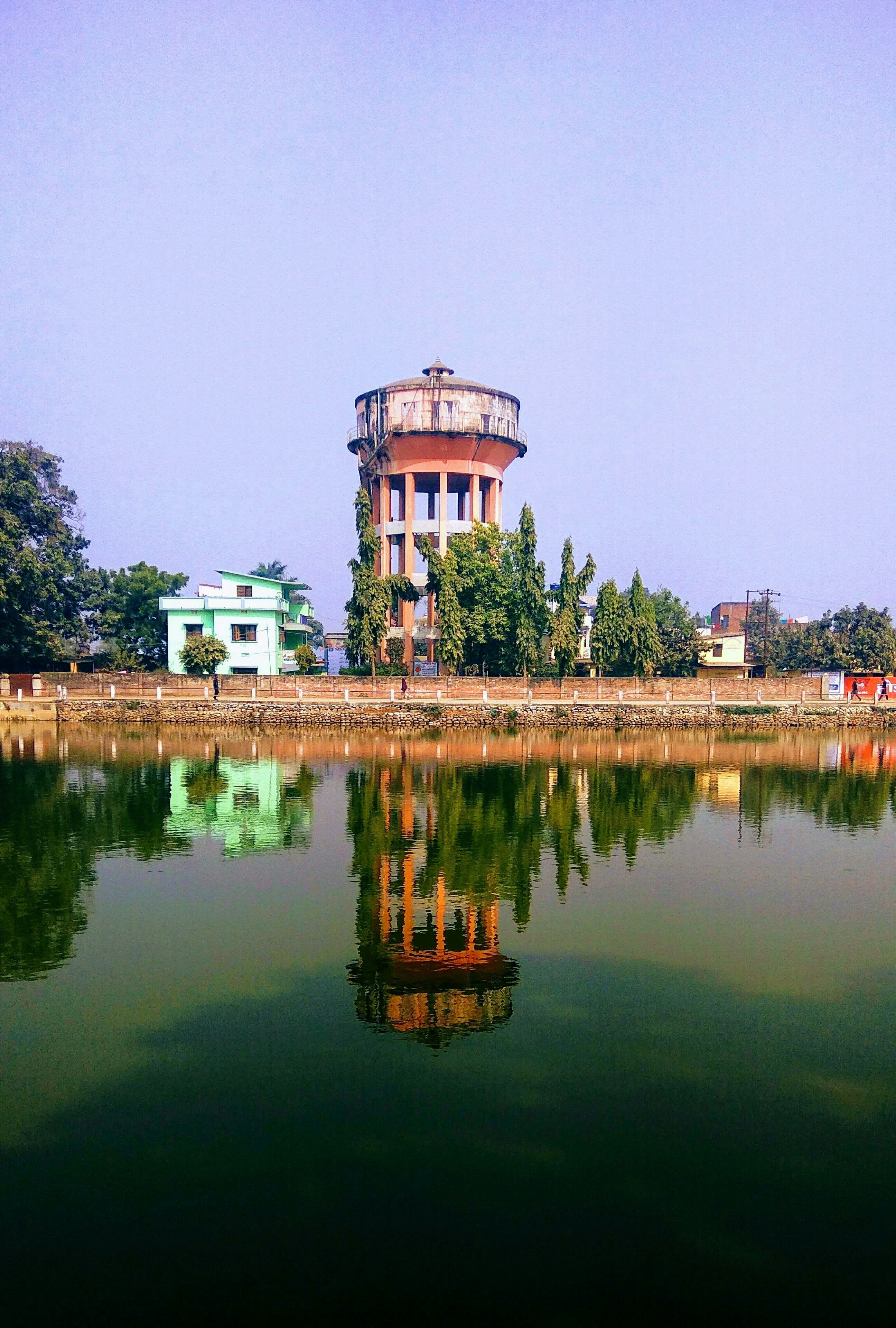 A large body of water with a building in the background photo – Free ...
