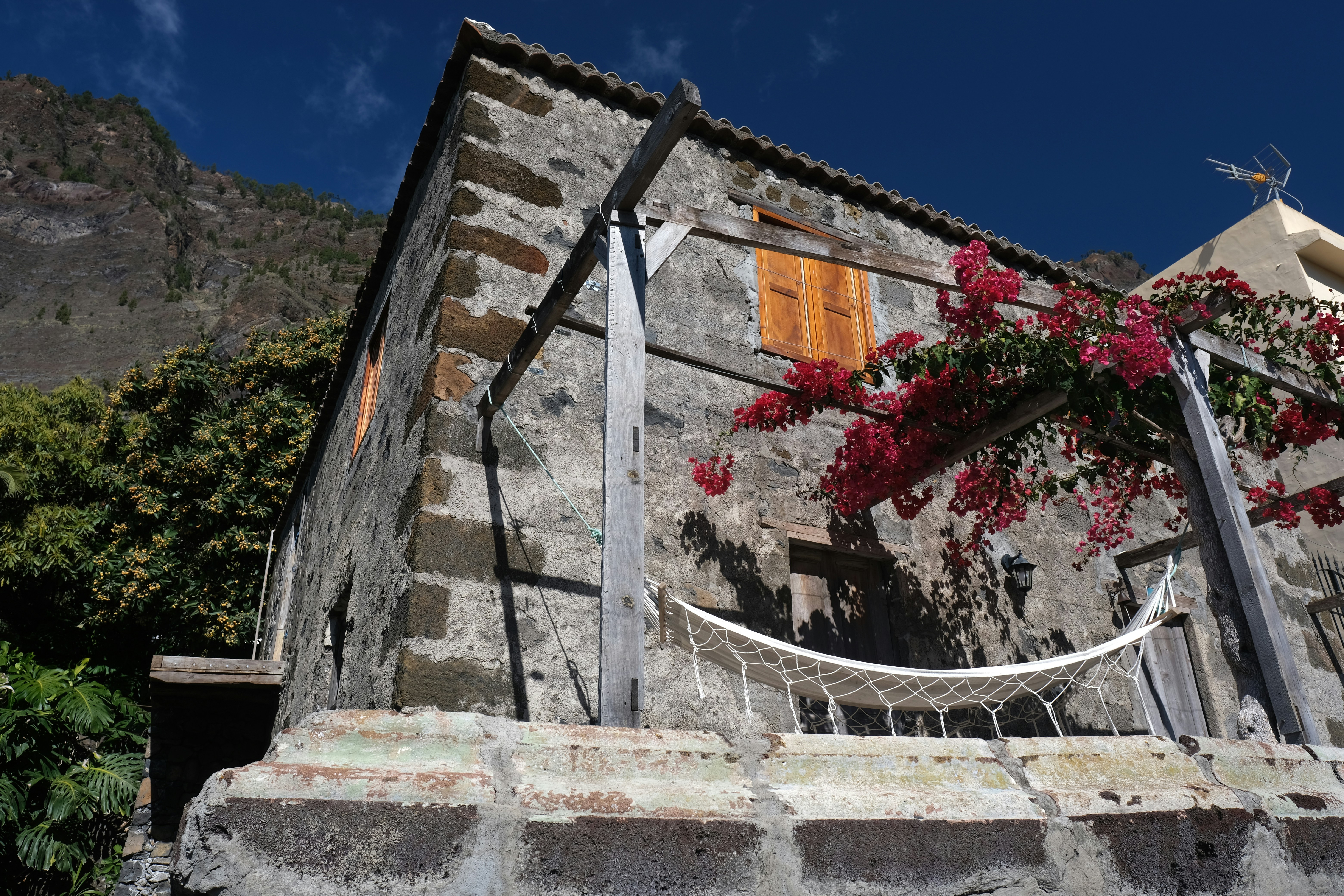 A hammock sits in front of a stone building photo – Free Caldera de ...