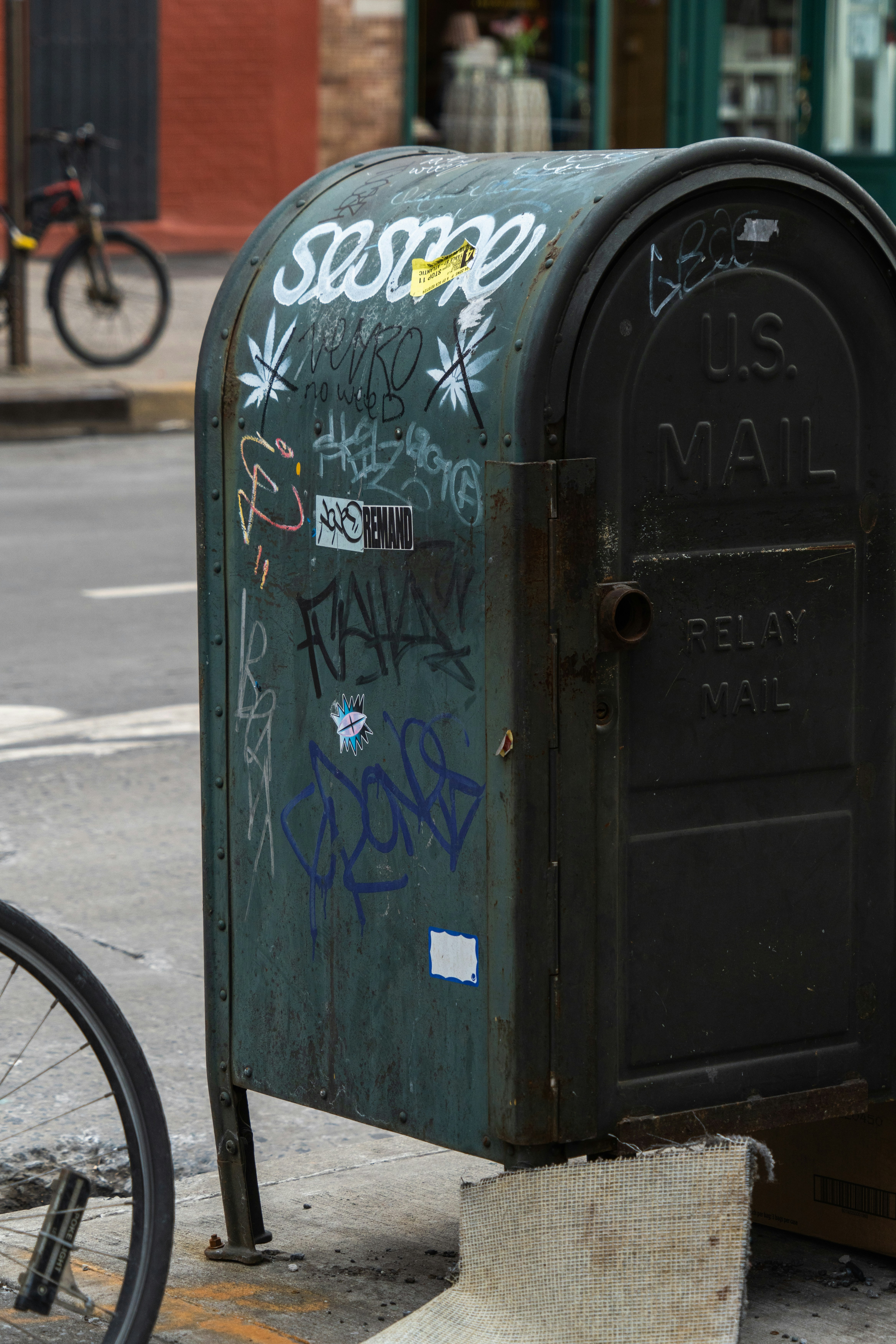 A mailbox with graffiti on it next to a bicycle photo – Free Beautiful ...