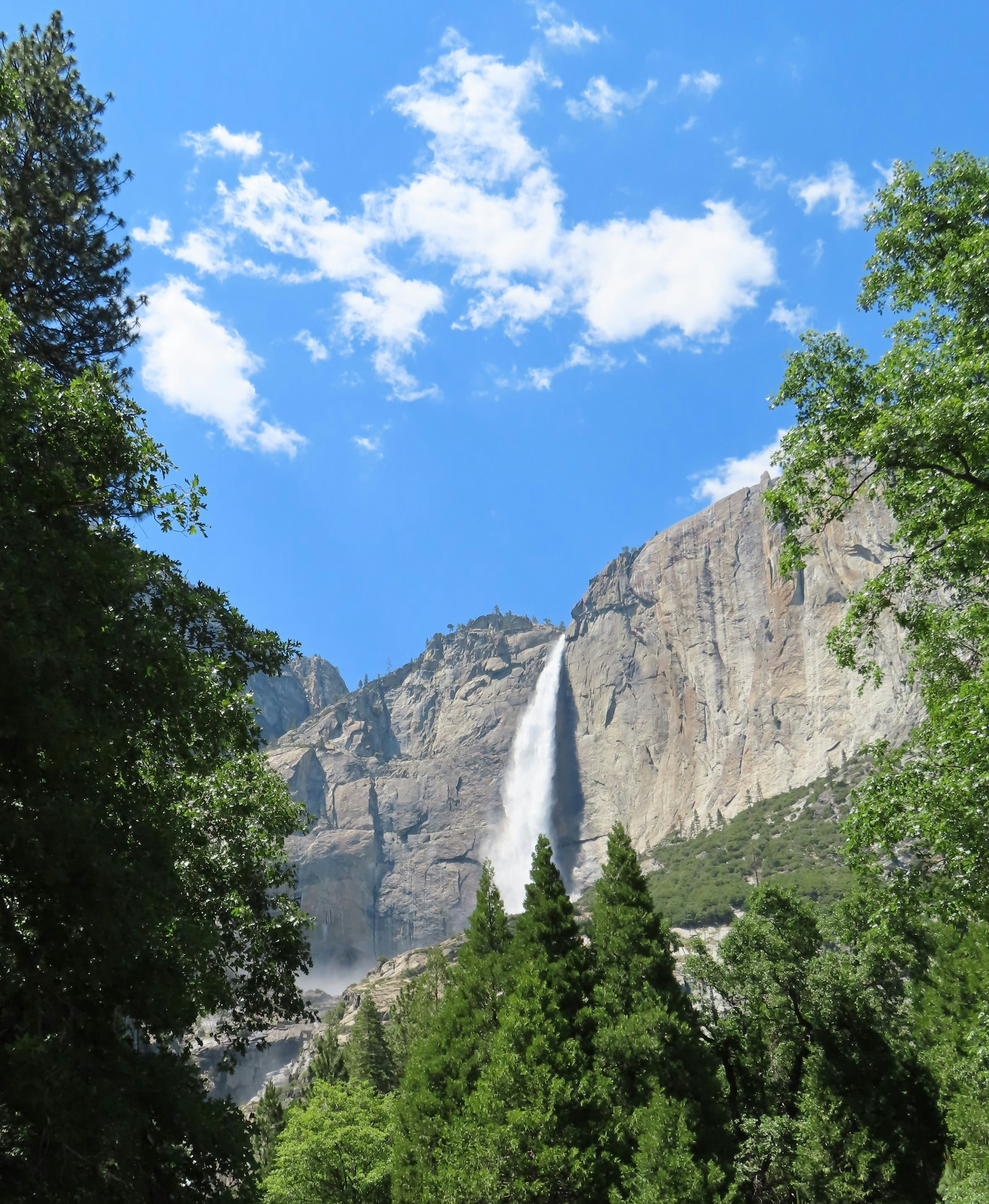 A waterfall is seen from the bottom of a mountain photo – Free Yosemite ...