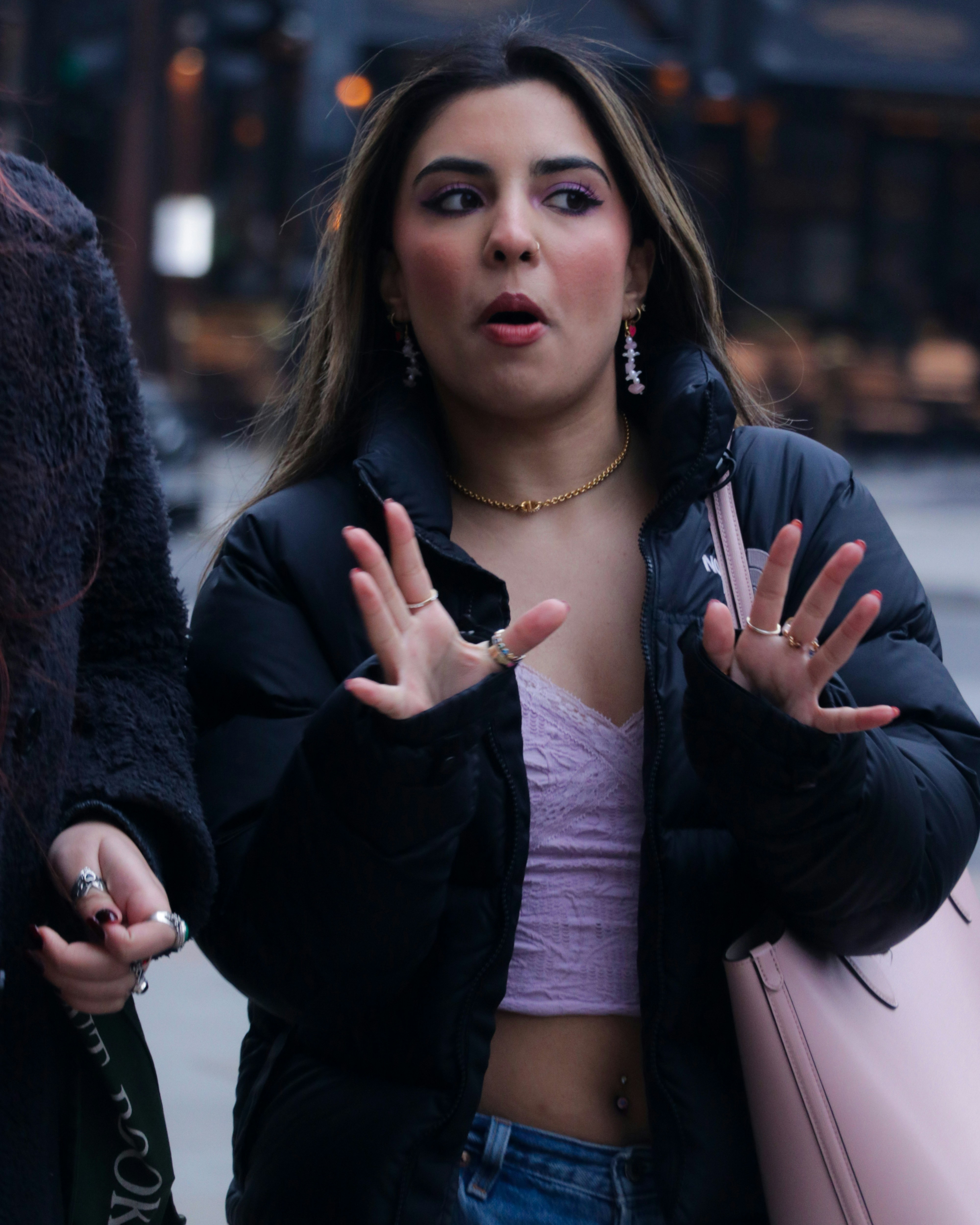 Raised Hands on a City Street: A Candid Moment