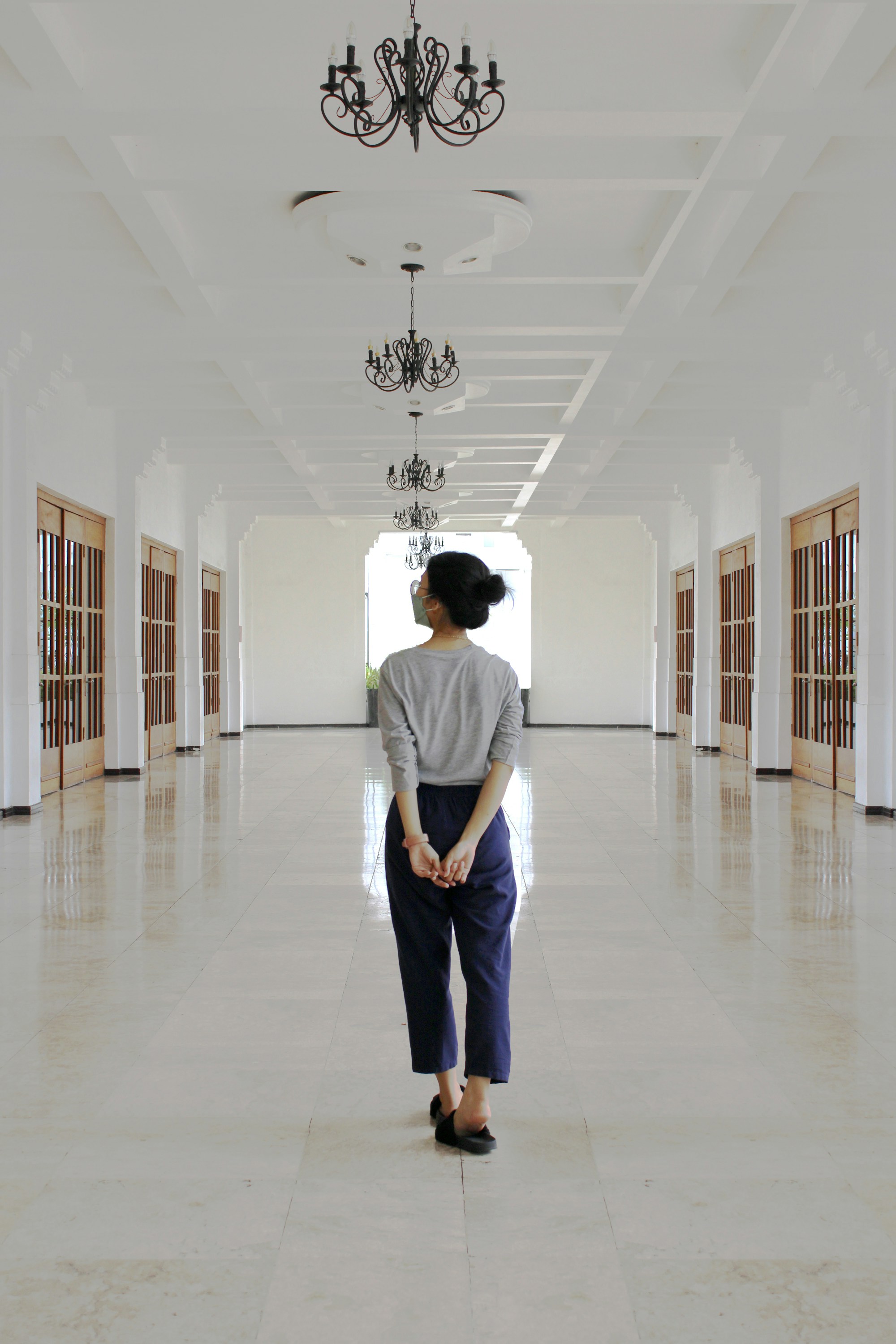 Centerfold in Light: A Solo Figure in a Grand Corridor