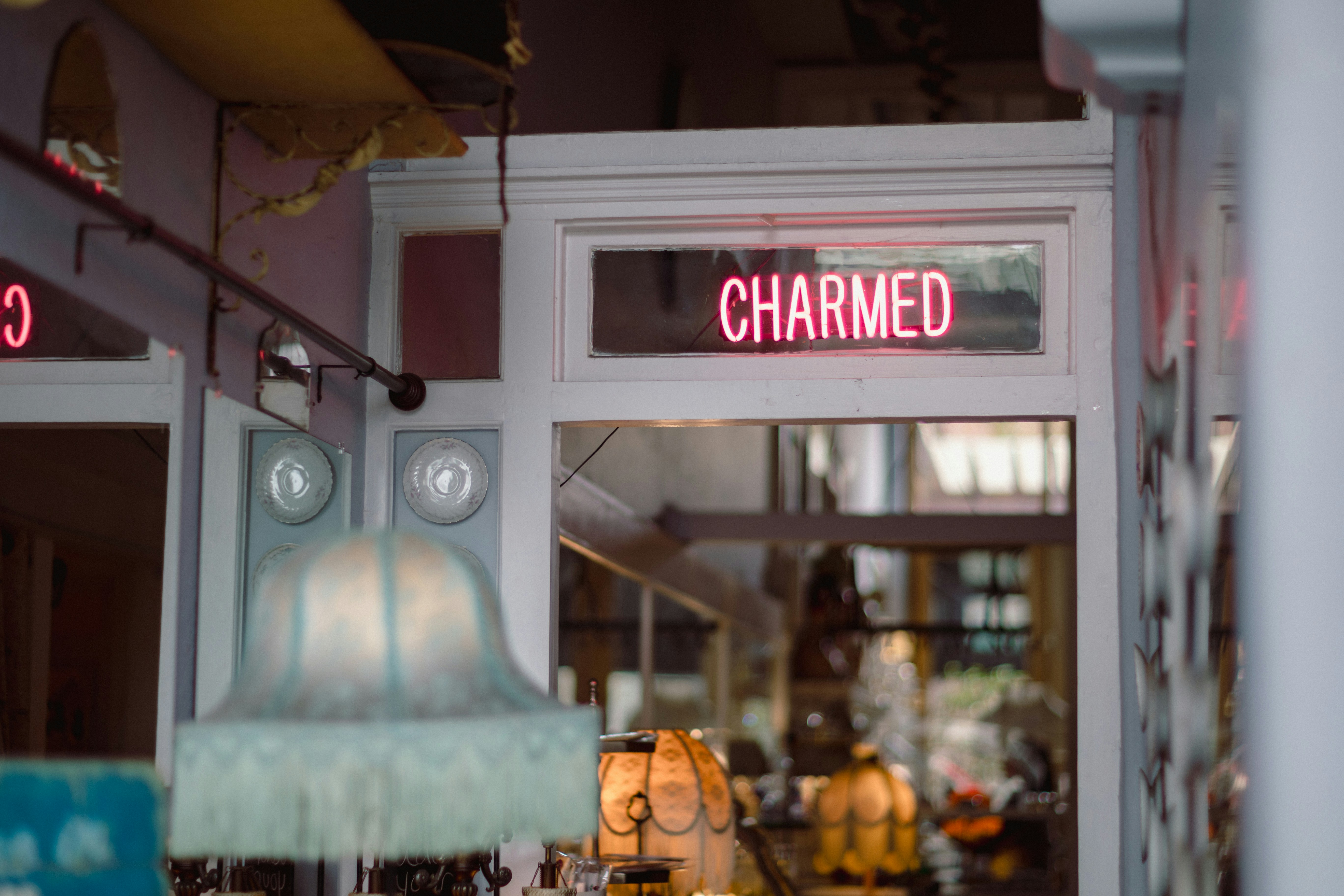 A store front with a lighted sign that says charmed photo – Free ...