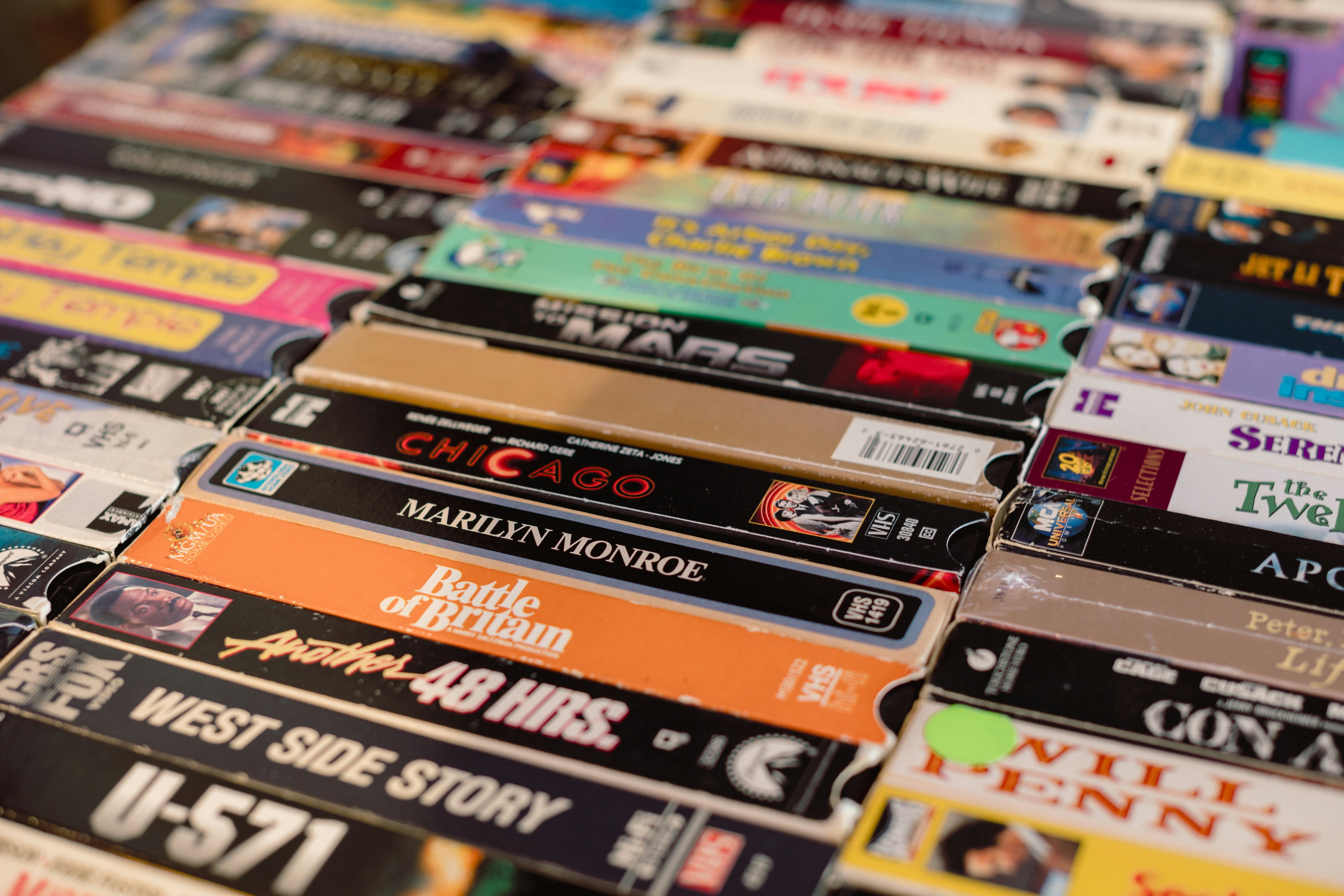 A bunch of different types of dvds on a table photo – Free Human Image ...