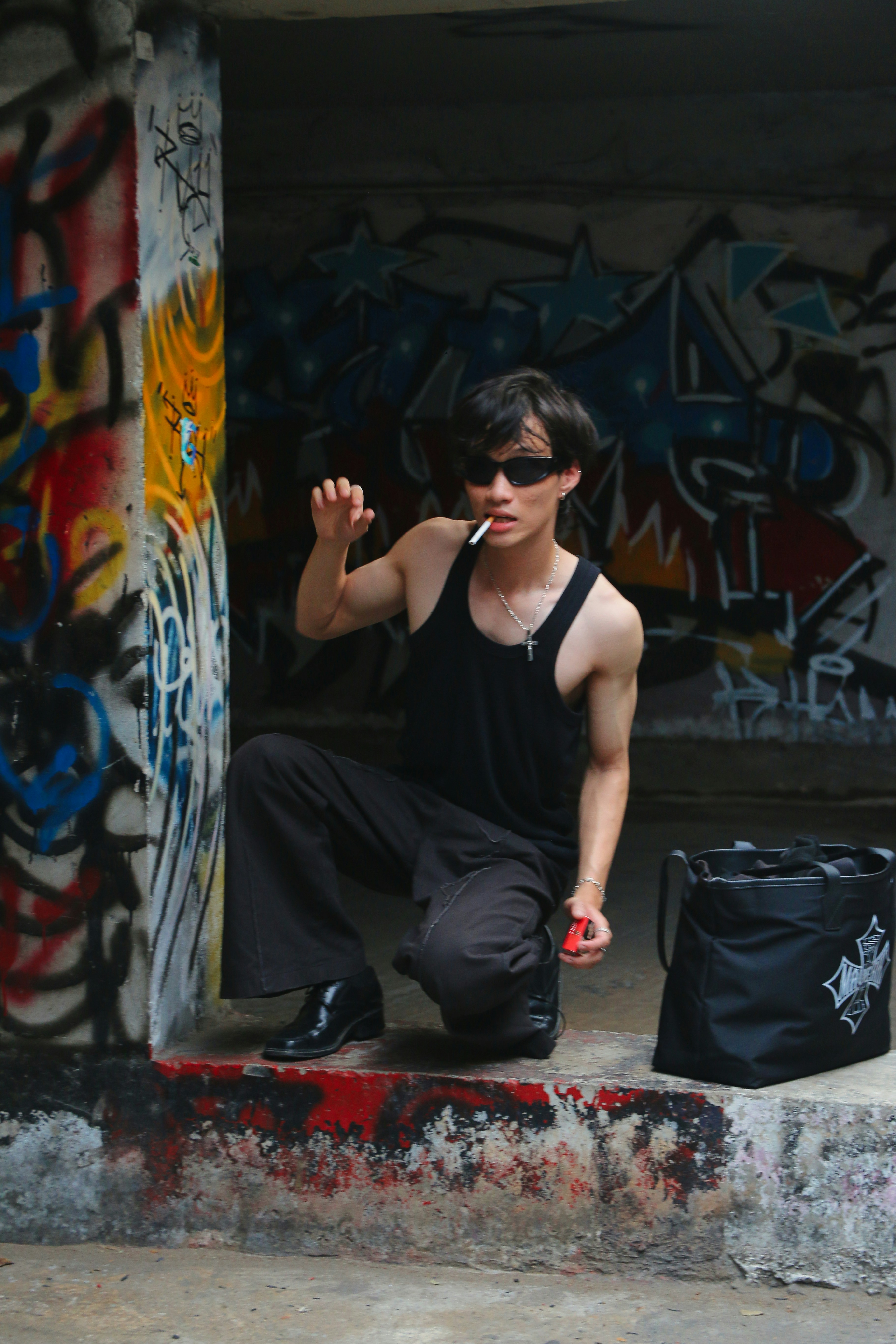 A man sitting on a step smoking a cigarette photo – Free Portrait Image ...