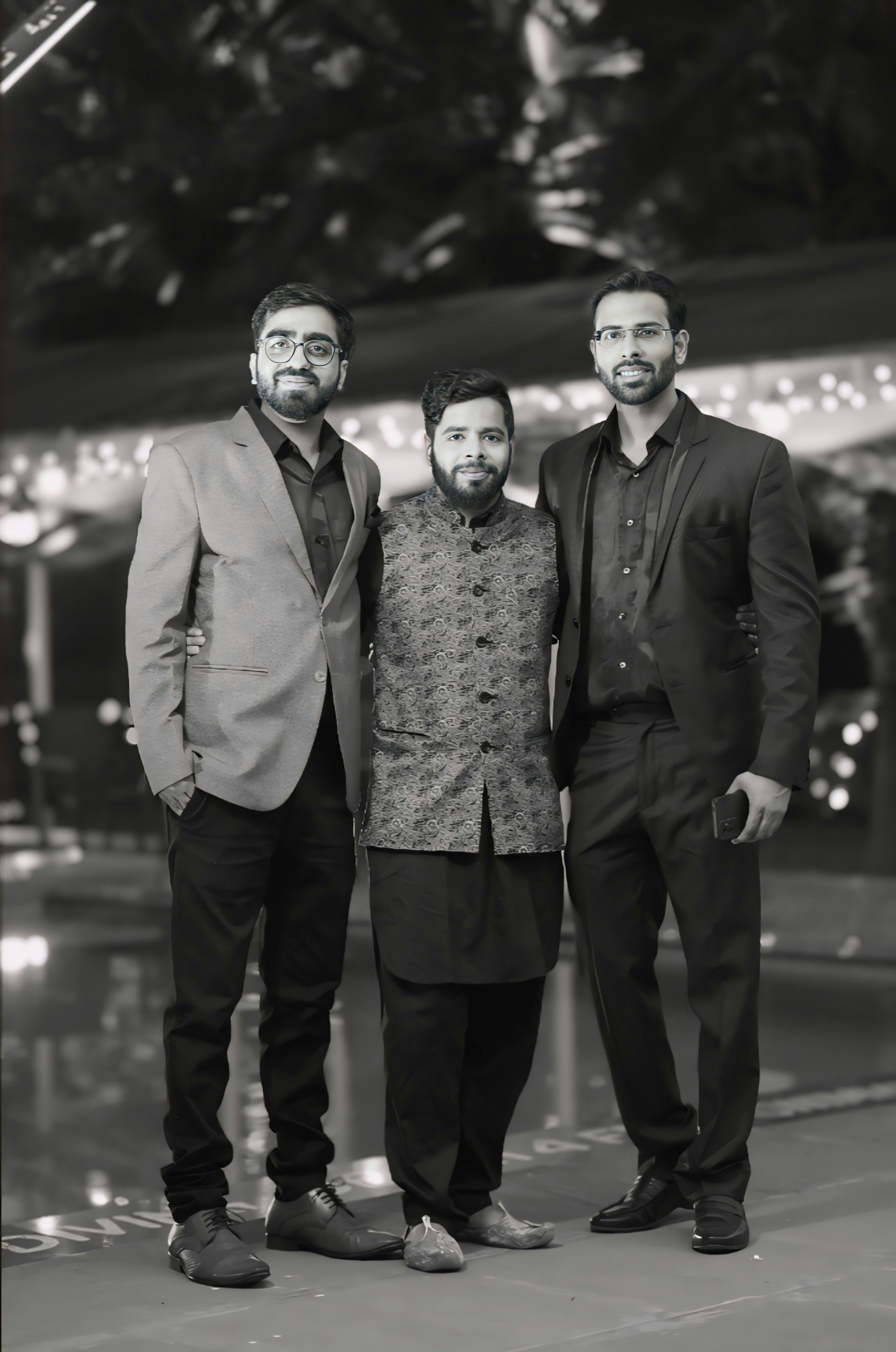 Three men standing next to each other in a black and white photo photo ...