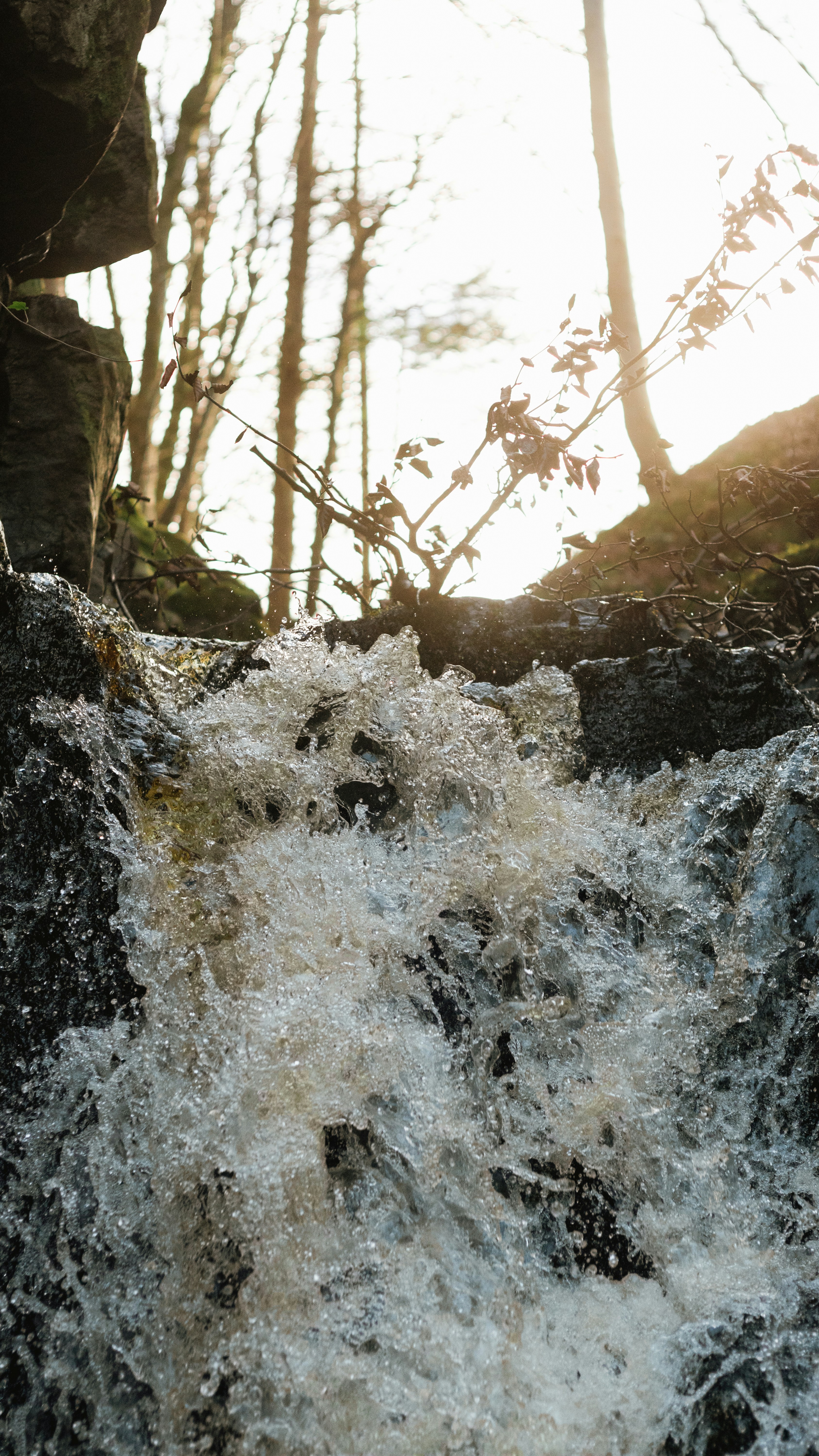 A low angle shot of the spray of a waterfall
