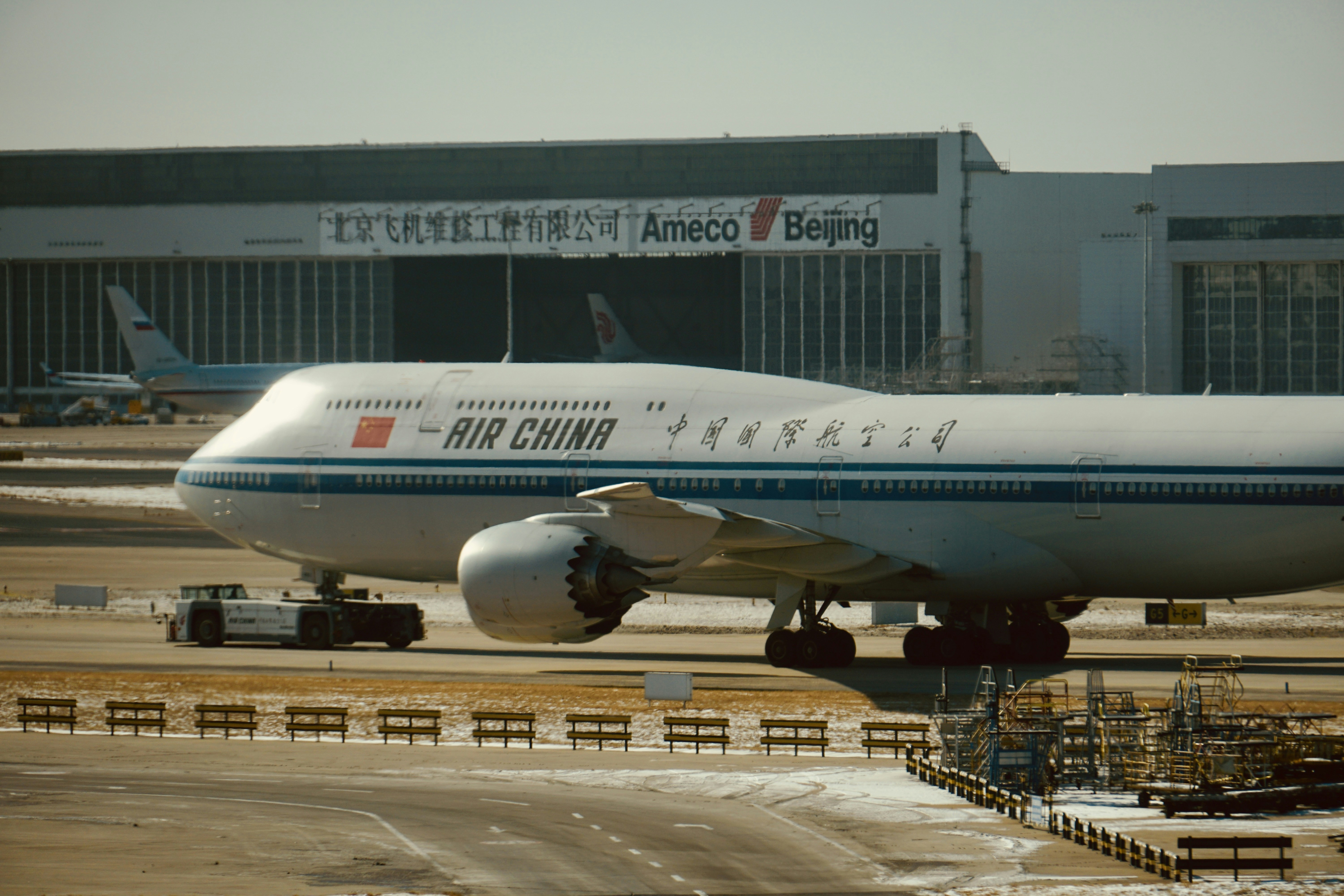 A large air china jetliner sitting on top of an airport tarmac photo ...