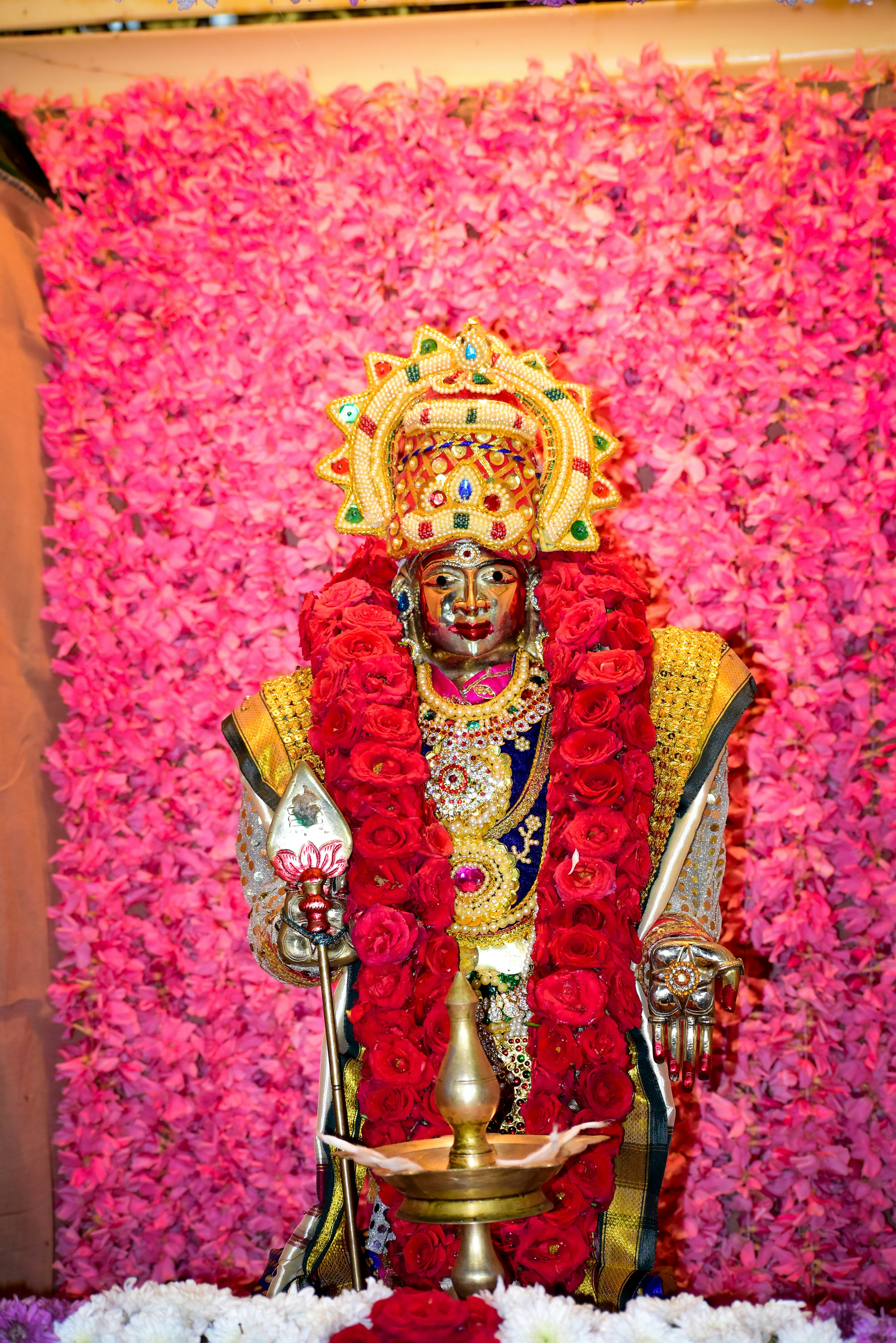 A statue of a hindu god surrounded by flowers photo – Free Murugan ...