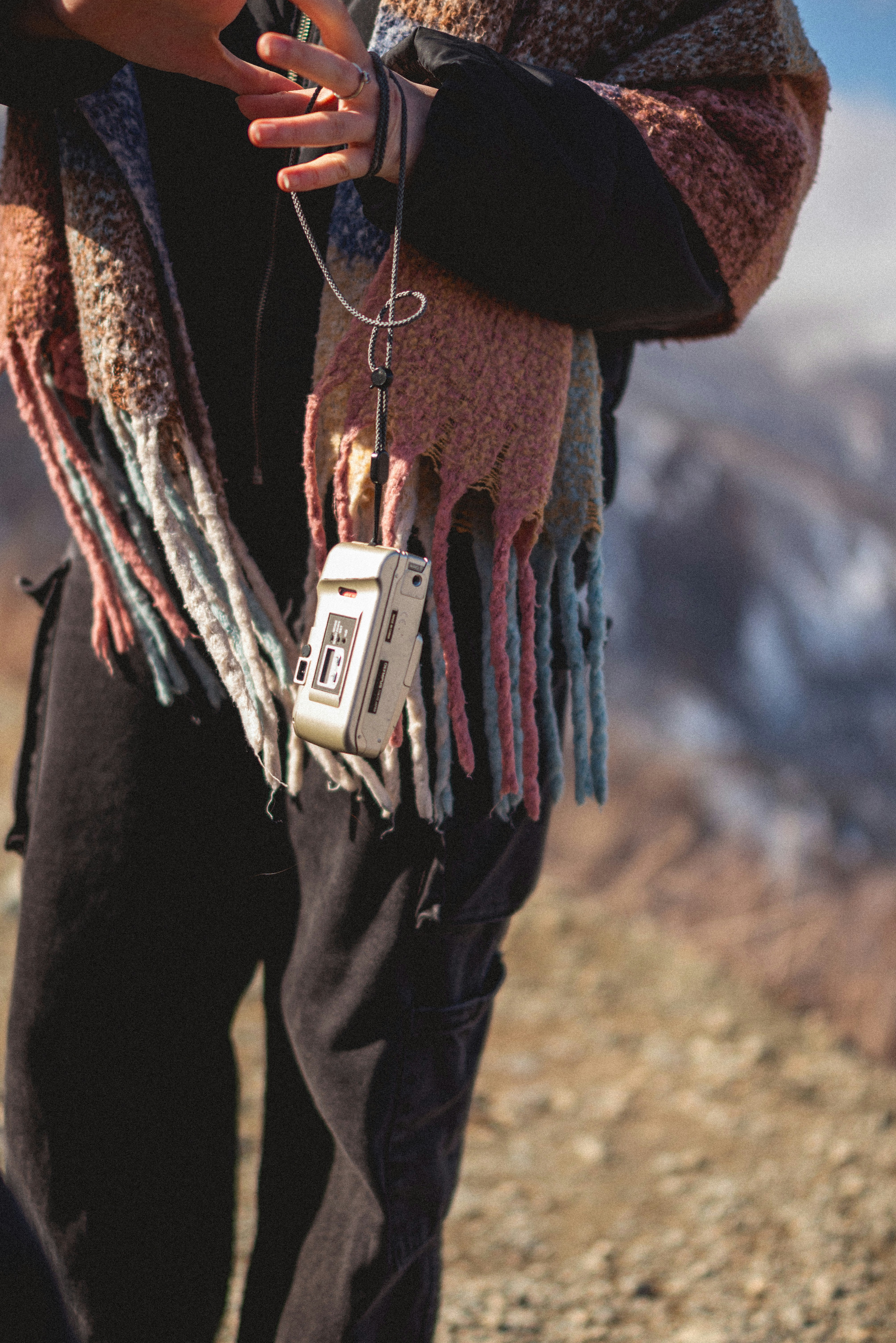 Holding a Vintage Moment: a Personal Film Camera on a Fringed Scarf