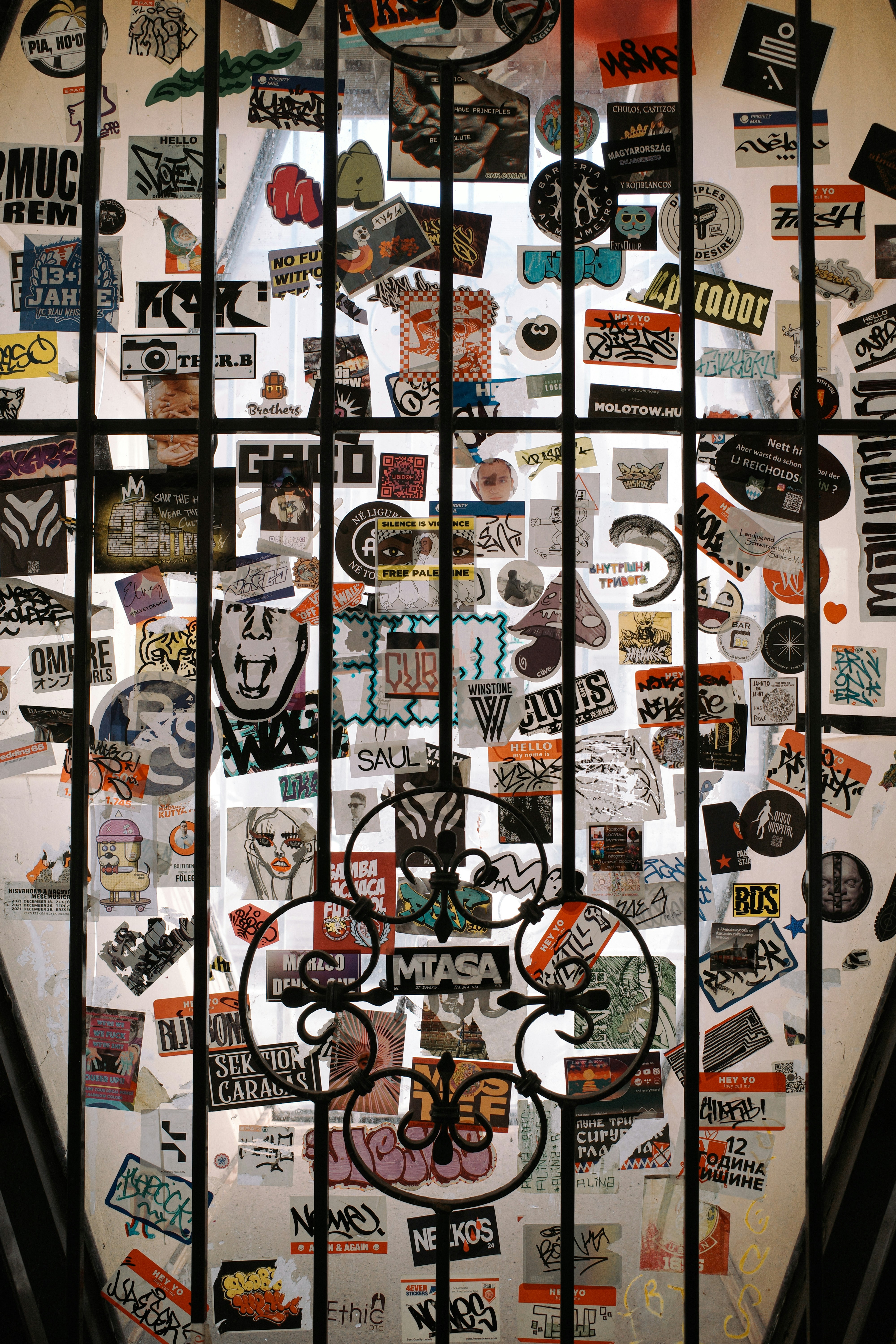 A bunch of stickers are on a window photo – Free Hungary Image on Unsplash