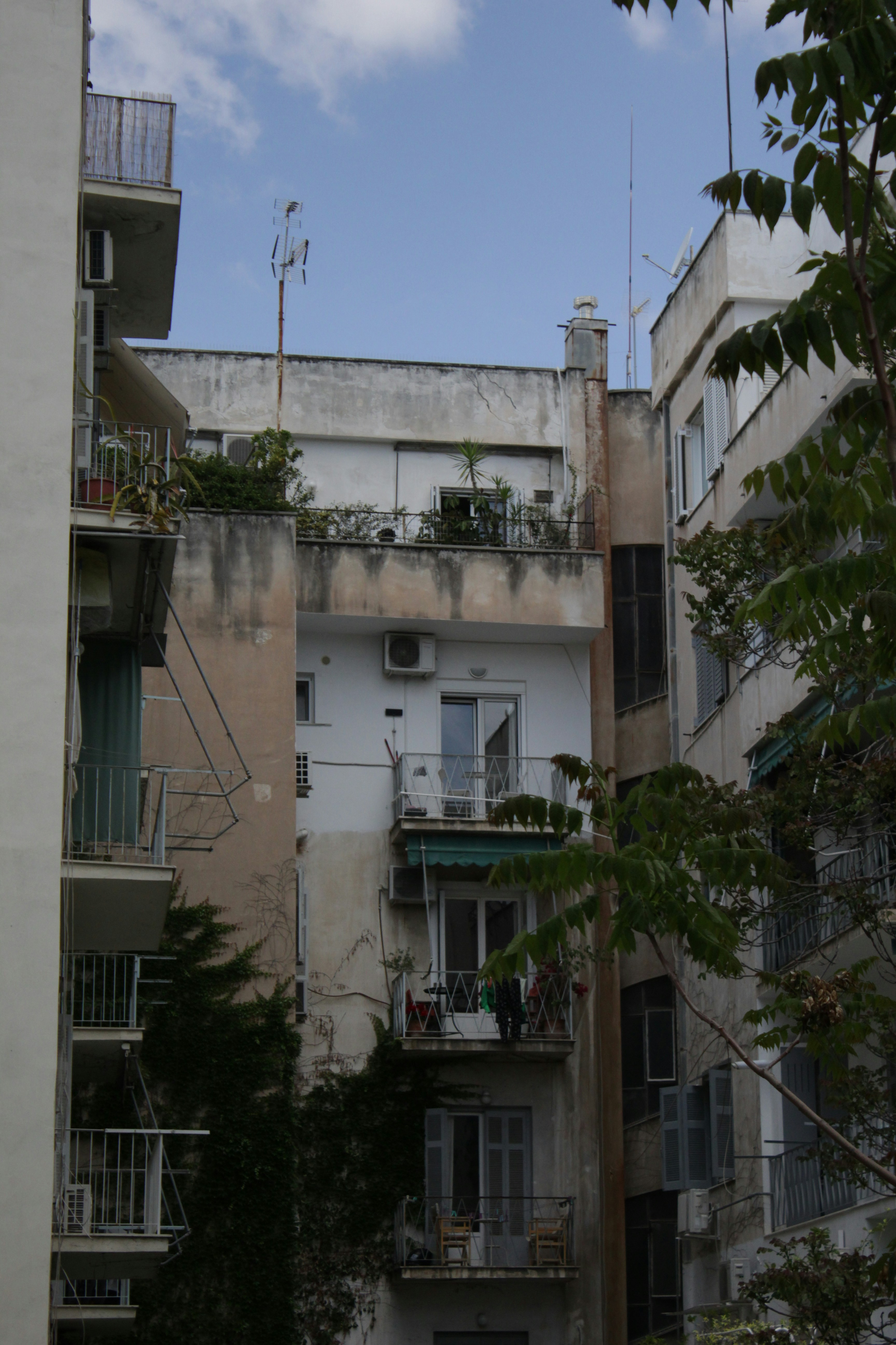 an apartment building with balconies and plants on the balconies
