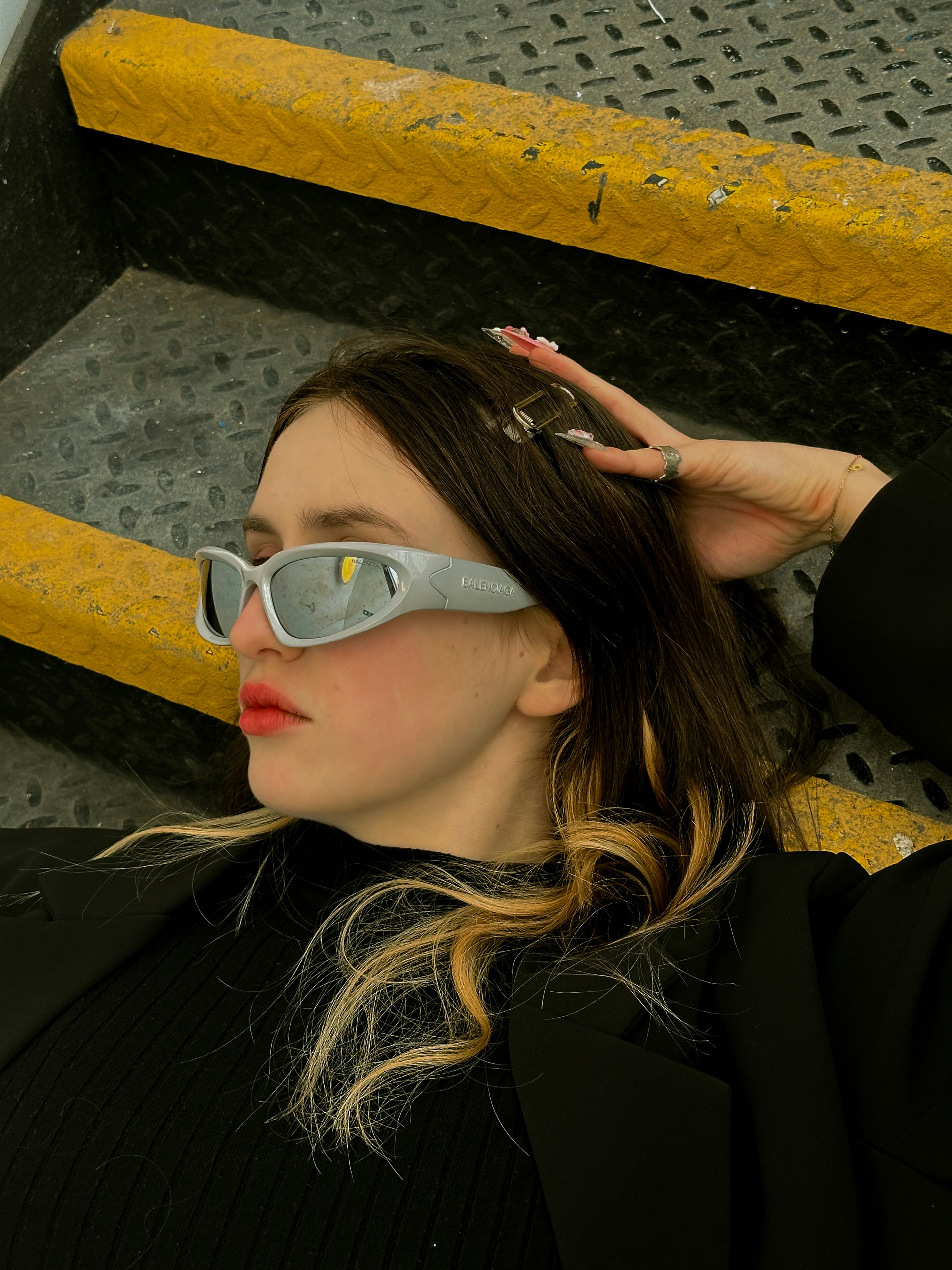 White Frames on Industrial Steps: A Quiet Portrait in Steel and Yellow